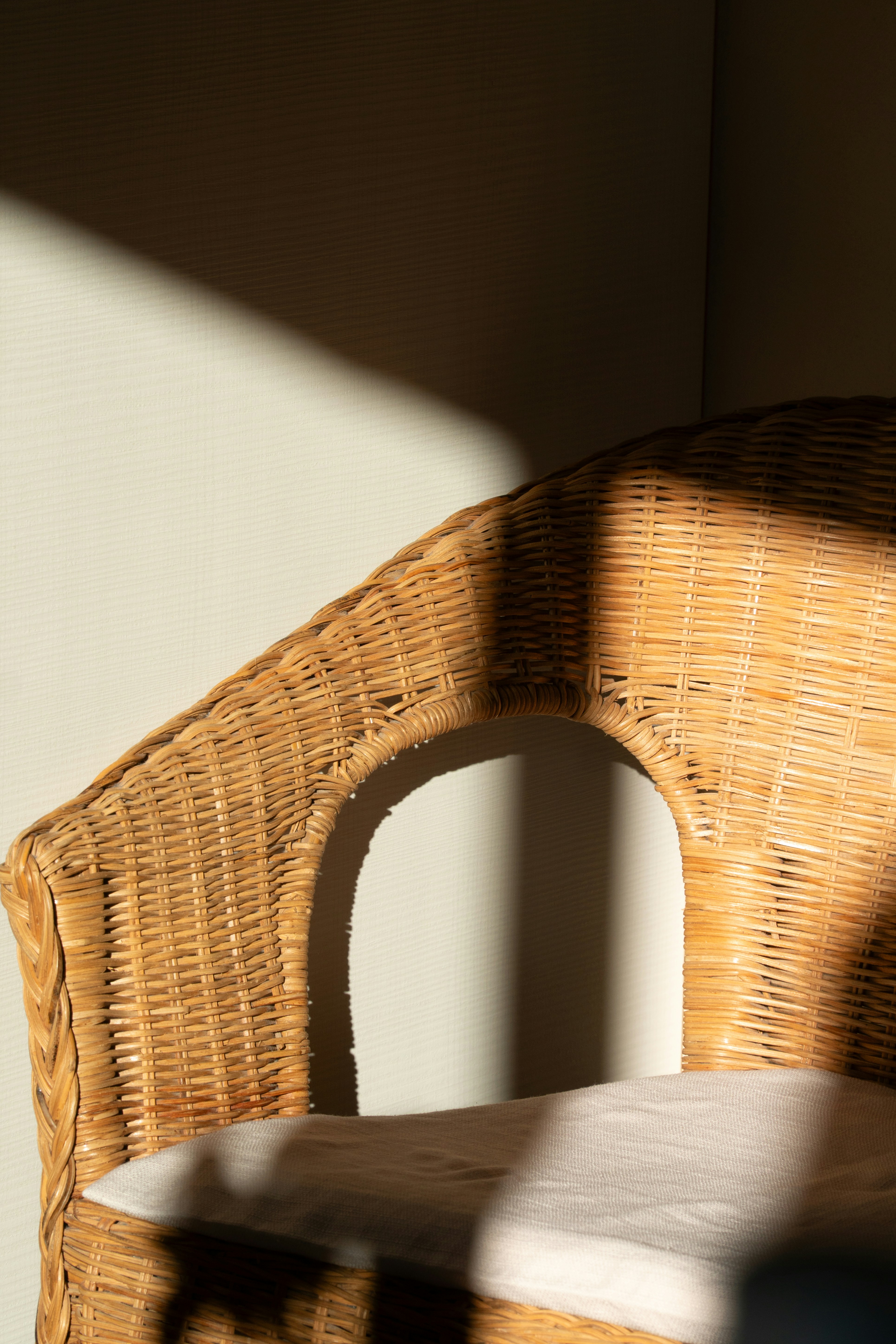 Wicker chair with sunlight and shadows