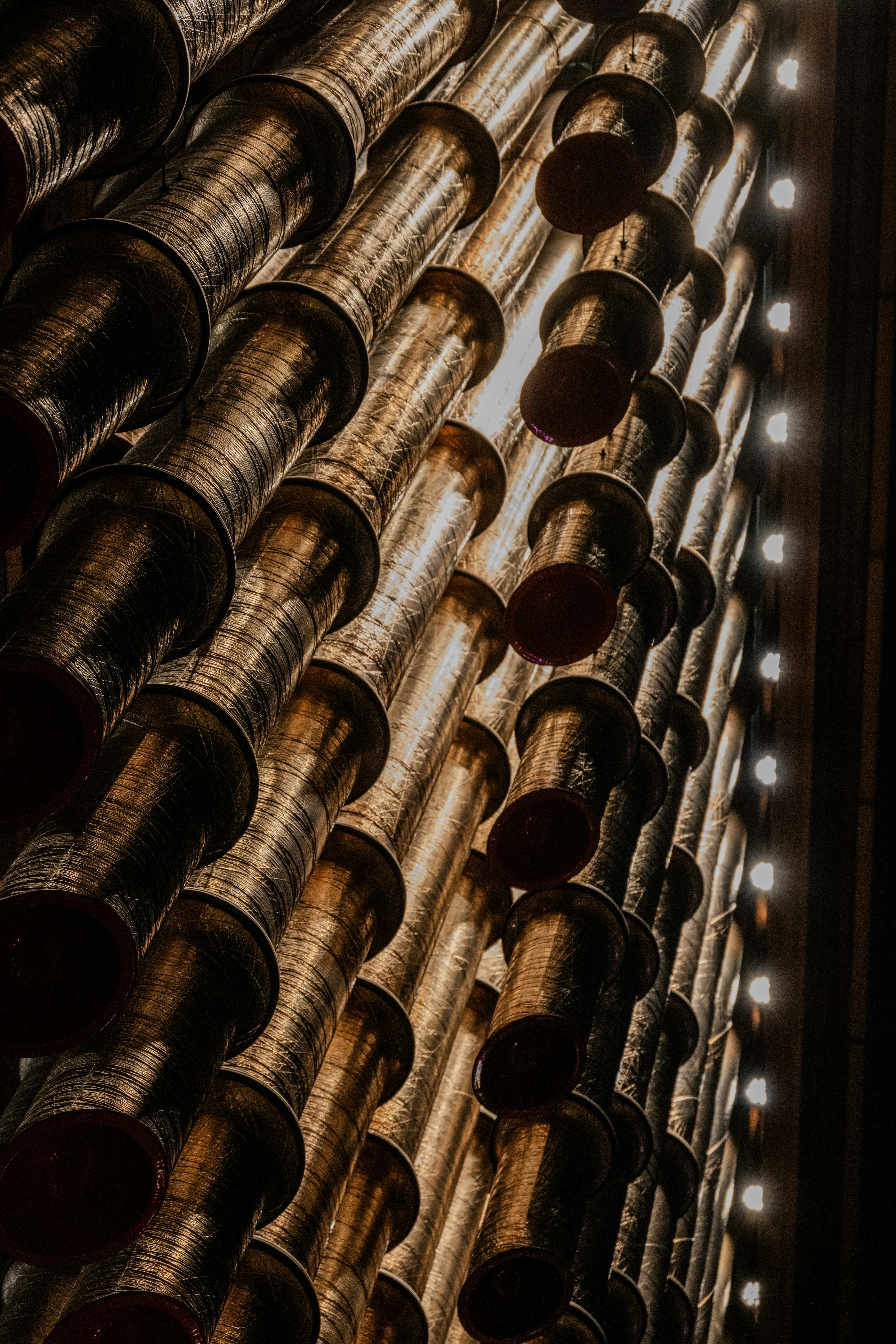 Close-up of stacked metallic cylinders with warm lighting.