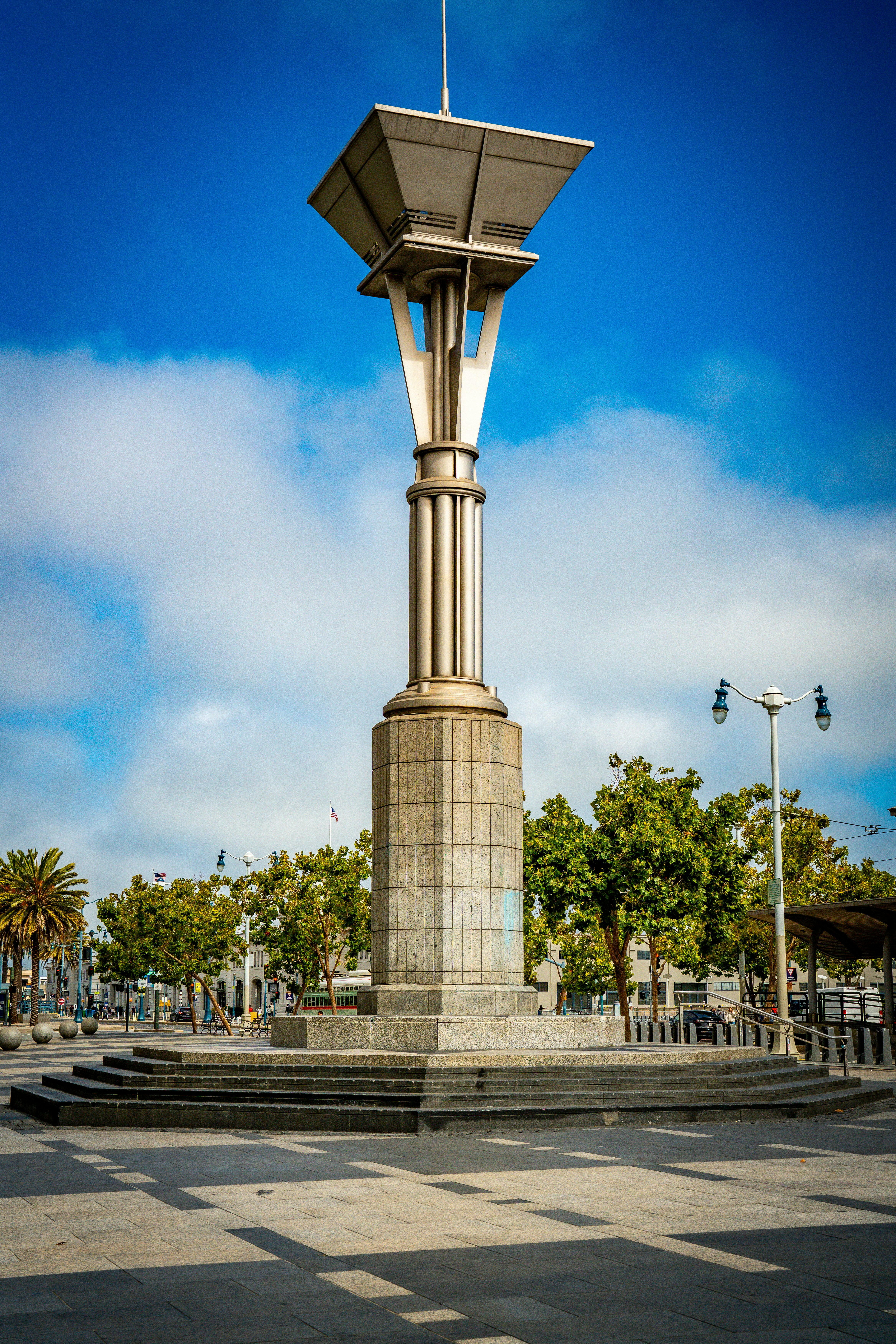 Modern monument with tiered base and blue sky