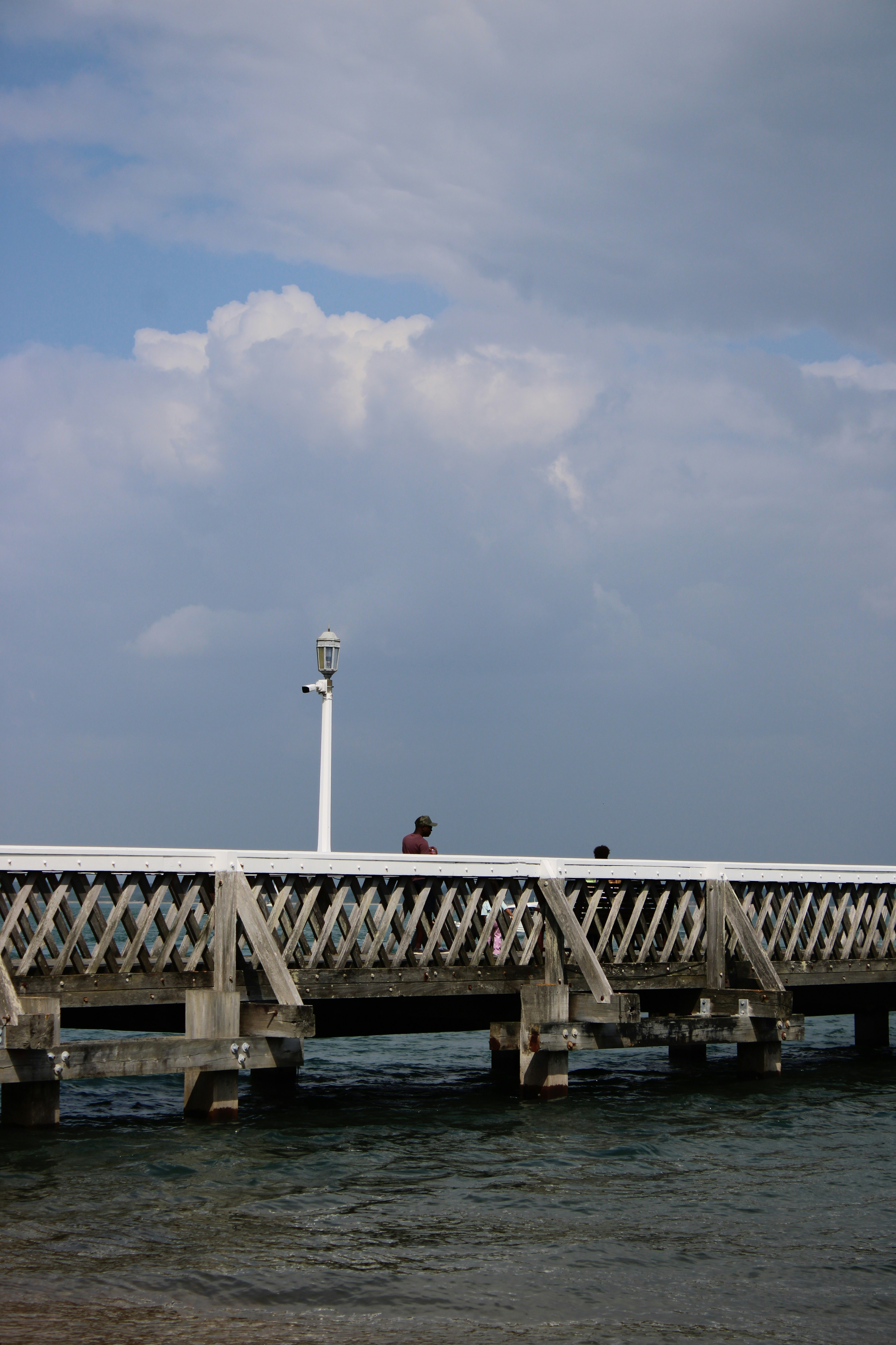 People on a pier overlooking the ocean