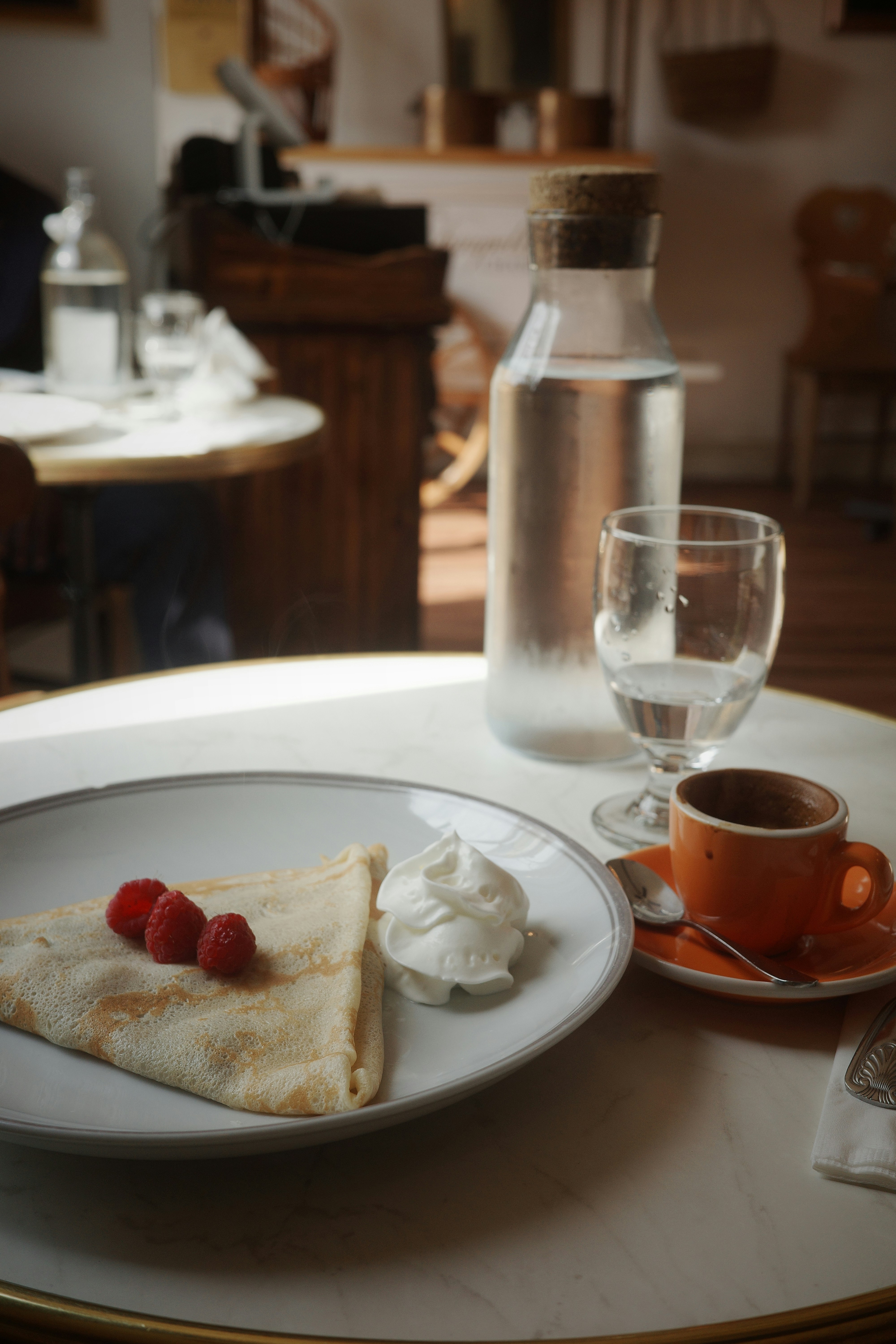 Crepe with raspberries and whipped cream with coffee