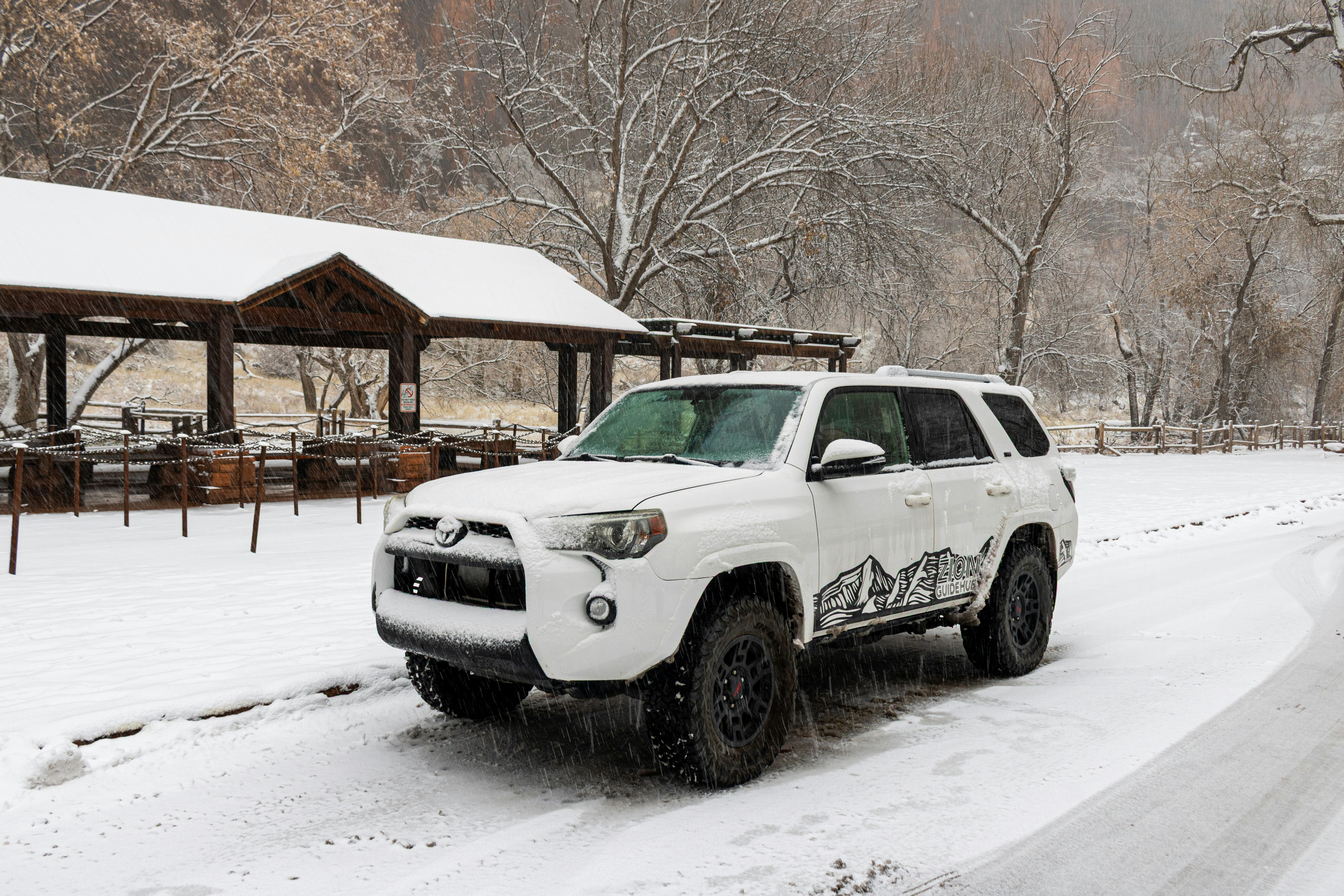 Snowbound Trail Warrior: White SUV Defies a Quiet Winter Park