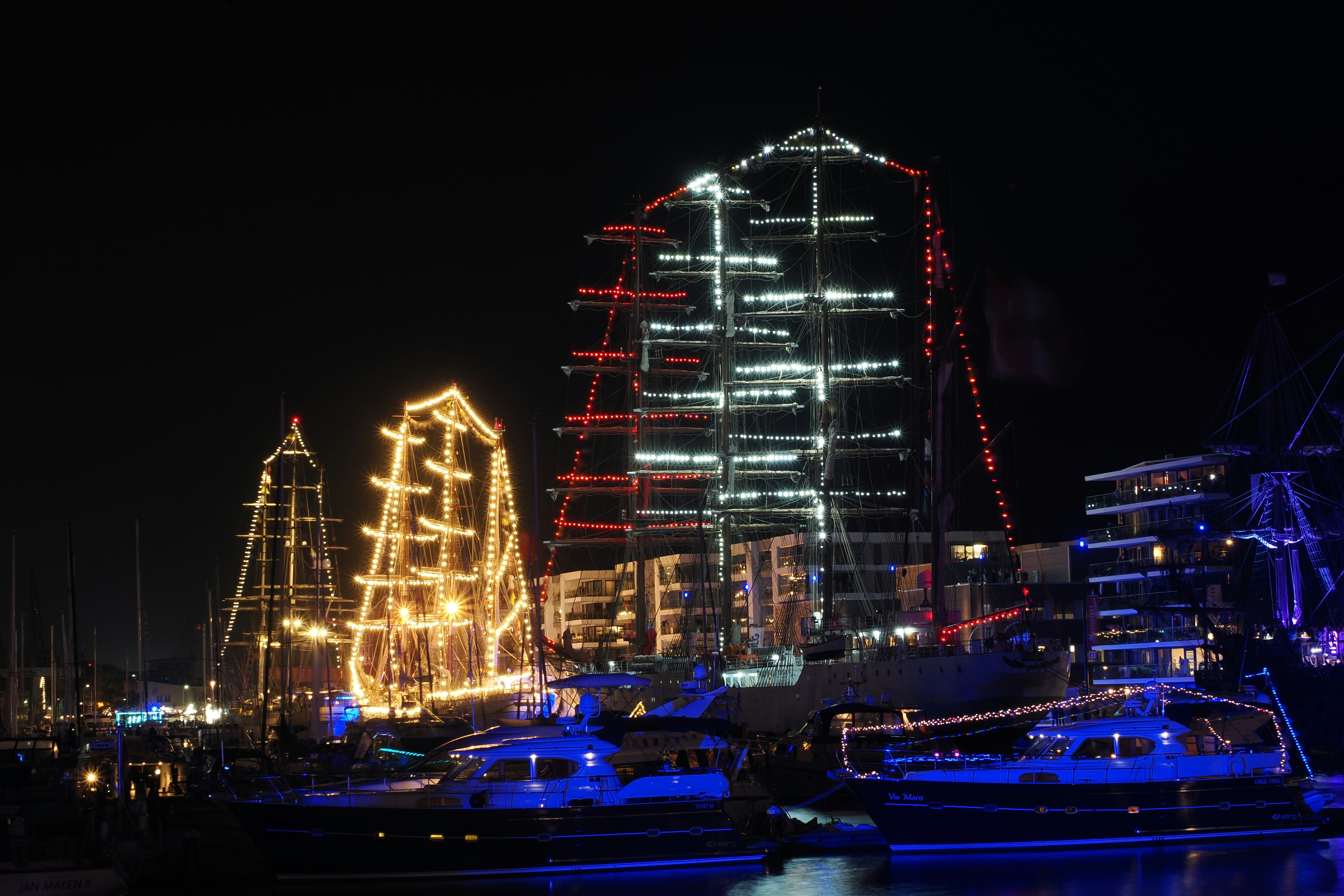 Luminous Rigging: Night Sails Docked Under Neon Masts