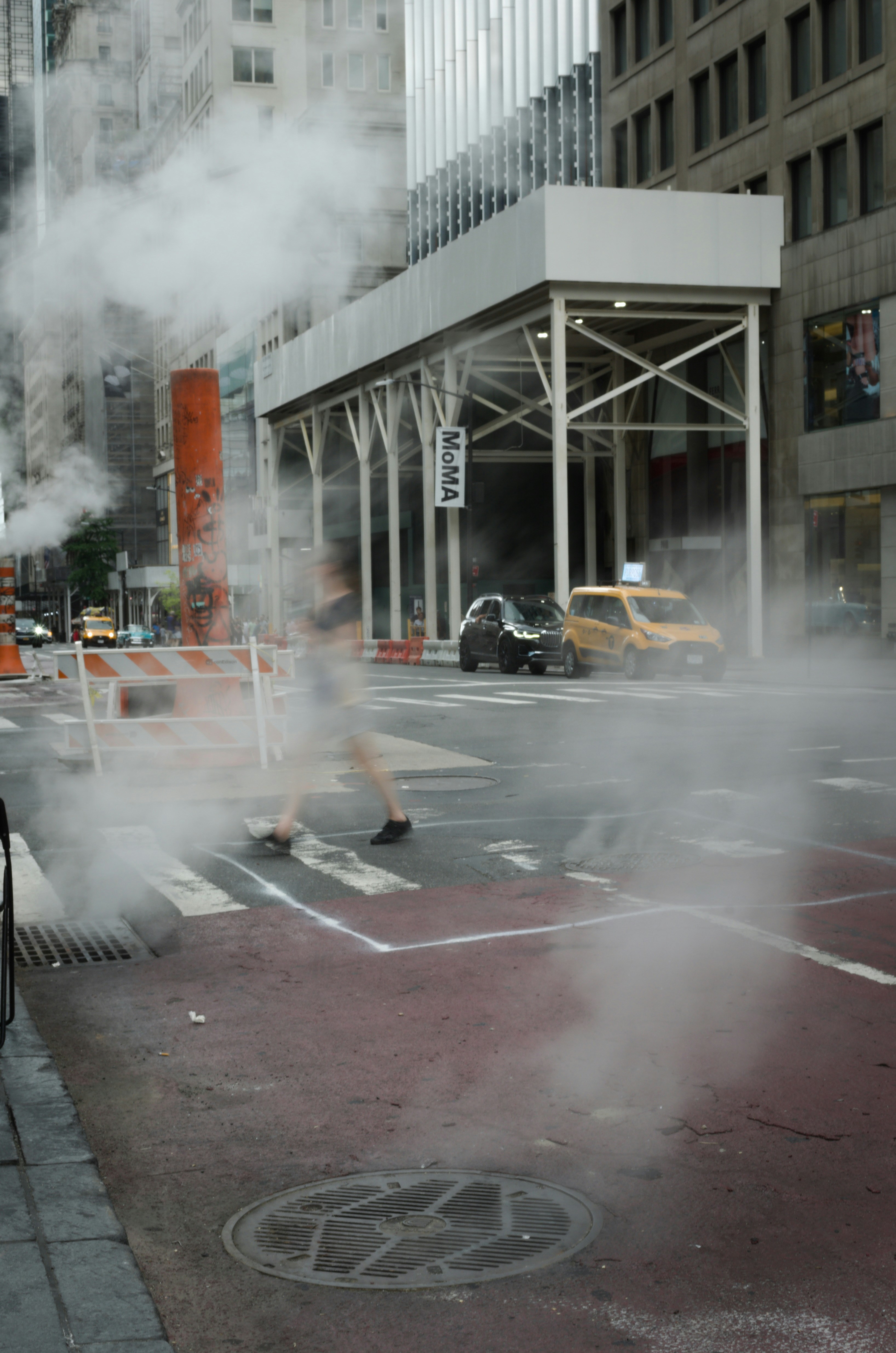 the famous smoking manholes | Steam rising from a street in a city.