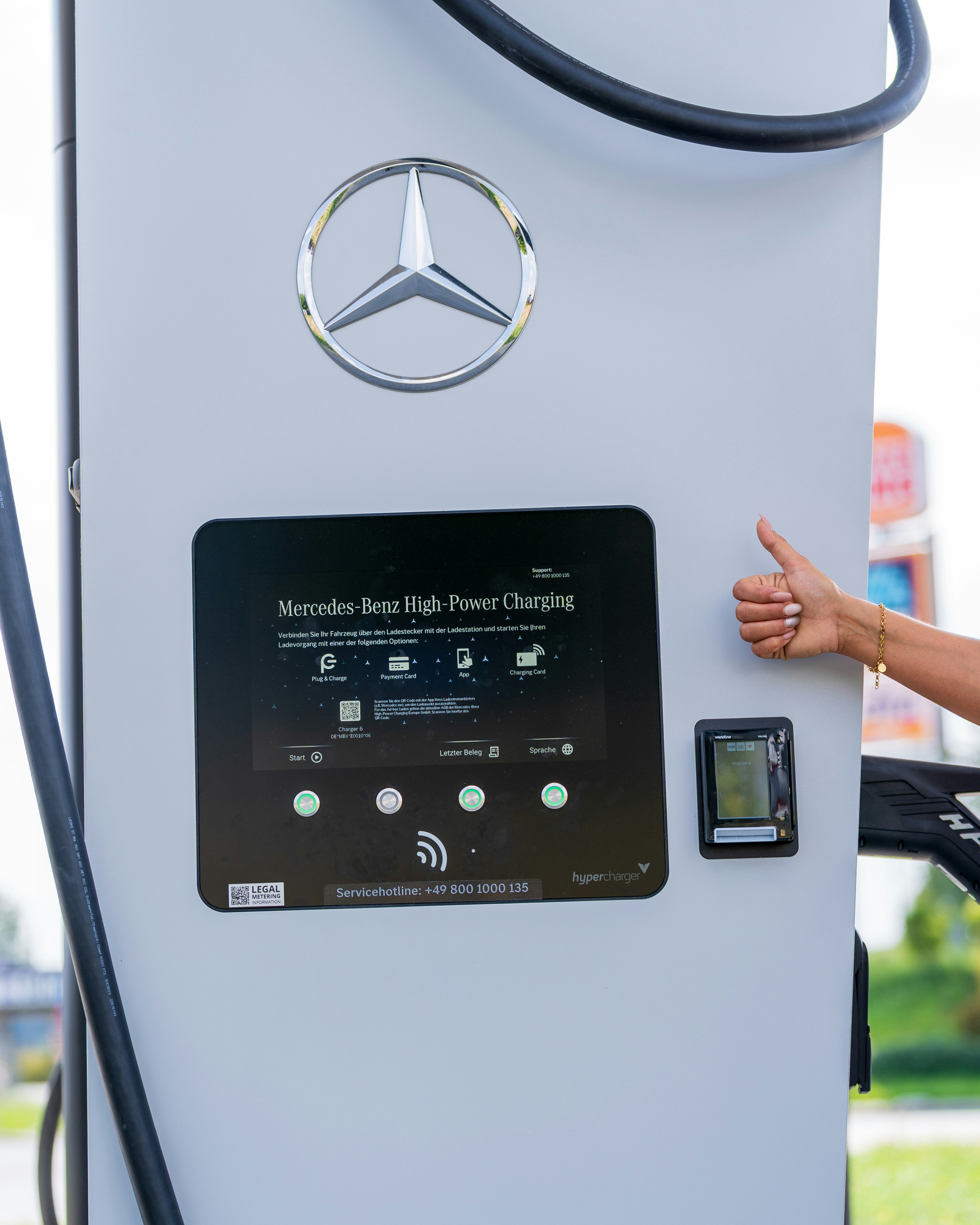 Mercedes-benz charging station with a person giving thumbs up. photo ...
