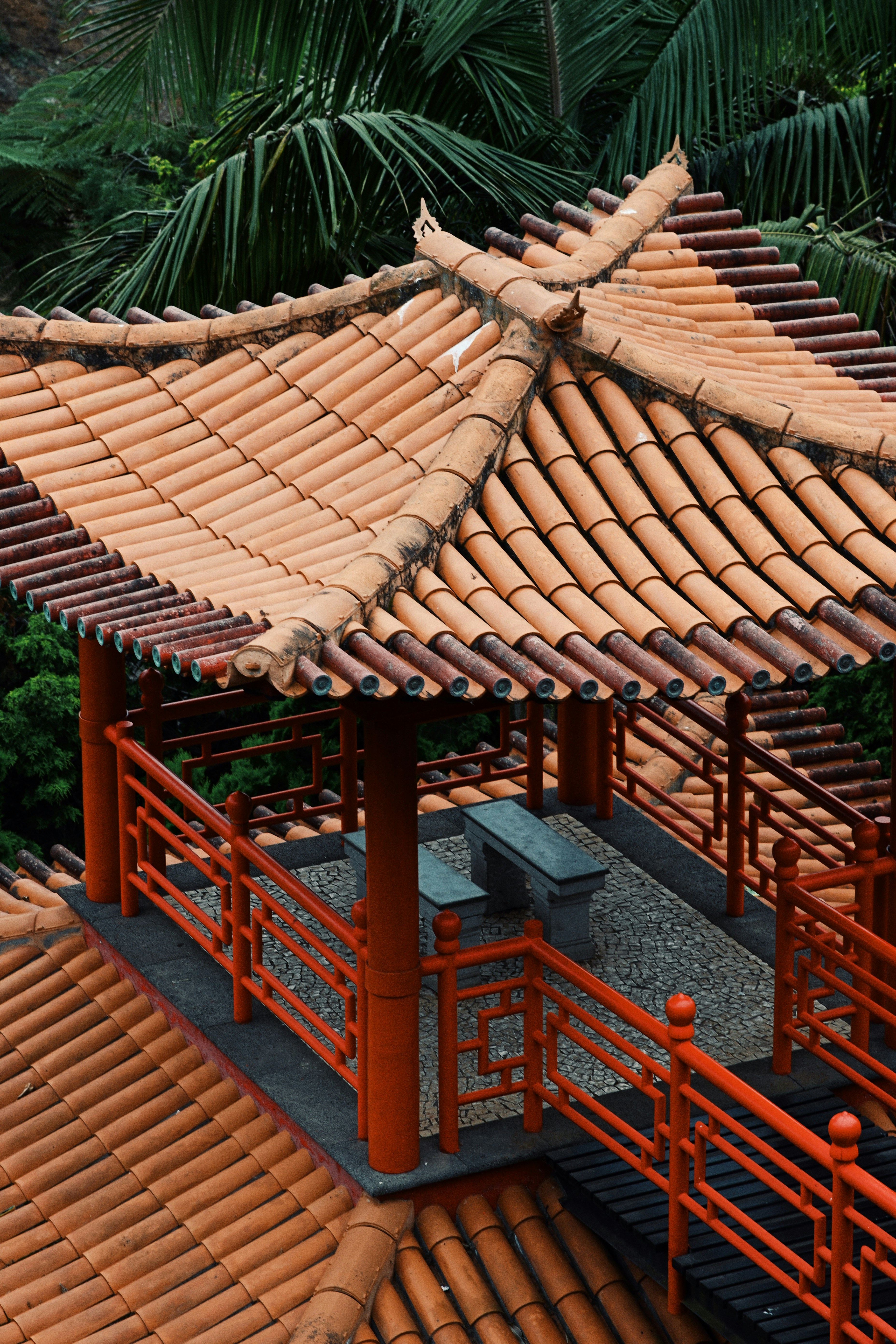 Traditional asian pavilion with tiled roof and red railings