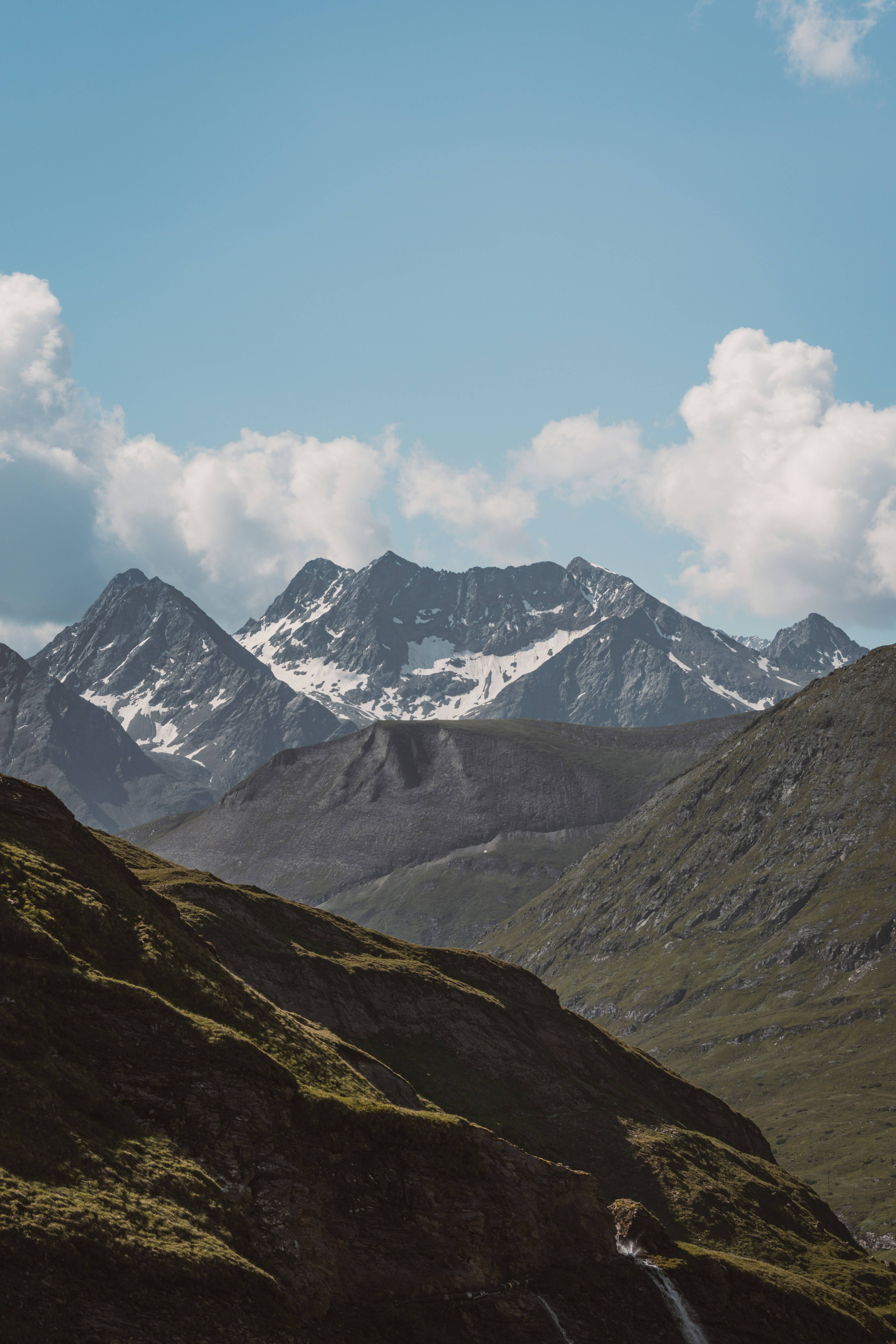 Rocky Peaks against Blue Skies | Snow-capped mountains under a blue sky