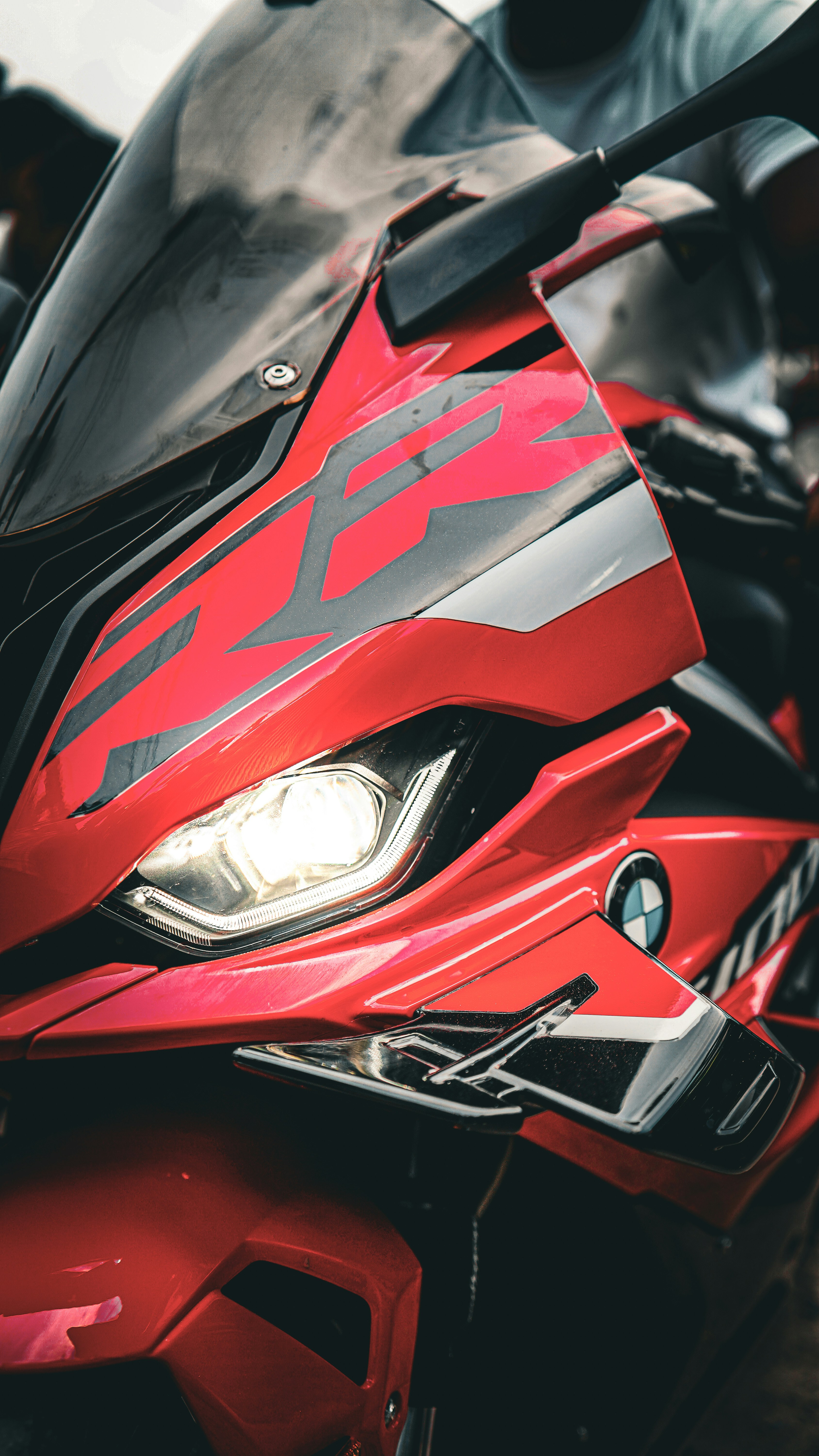 Red sport motorcycle with illuminated headlight
