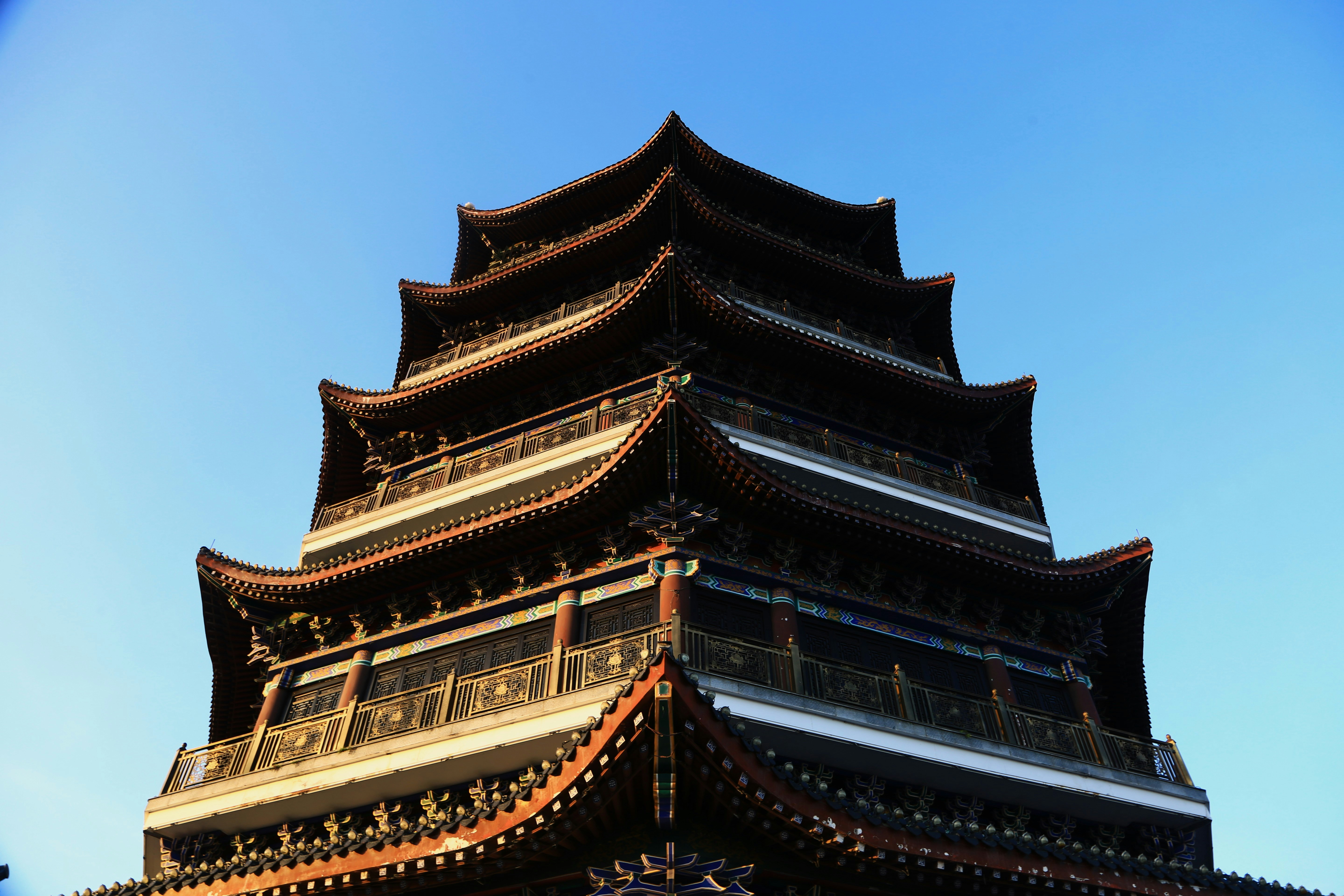 Traditional chinese pagoda against a clear blue sky.