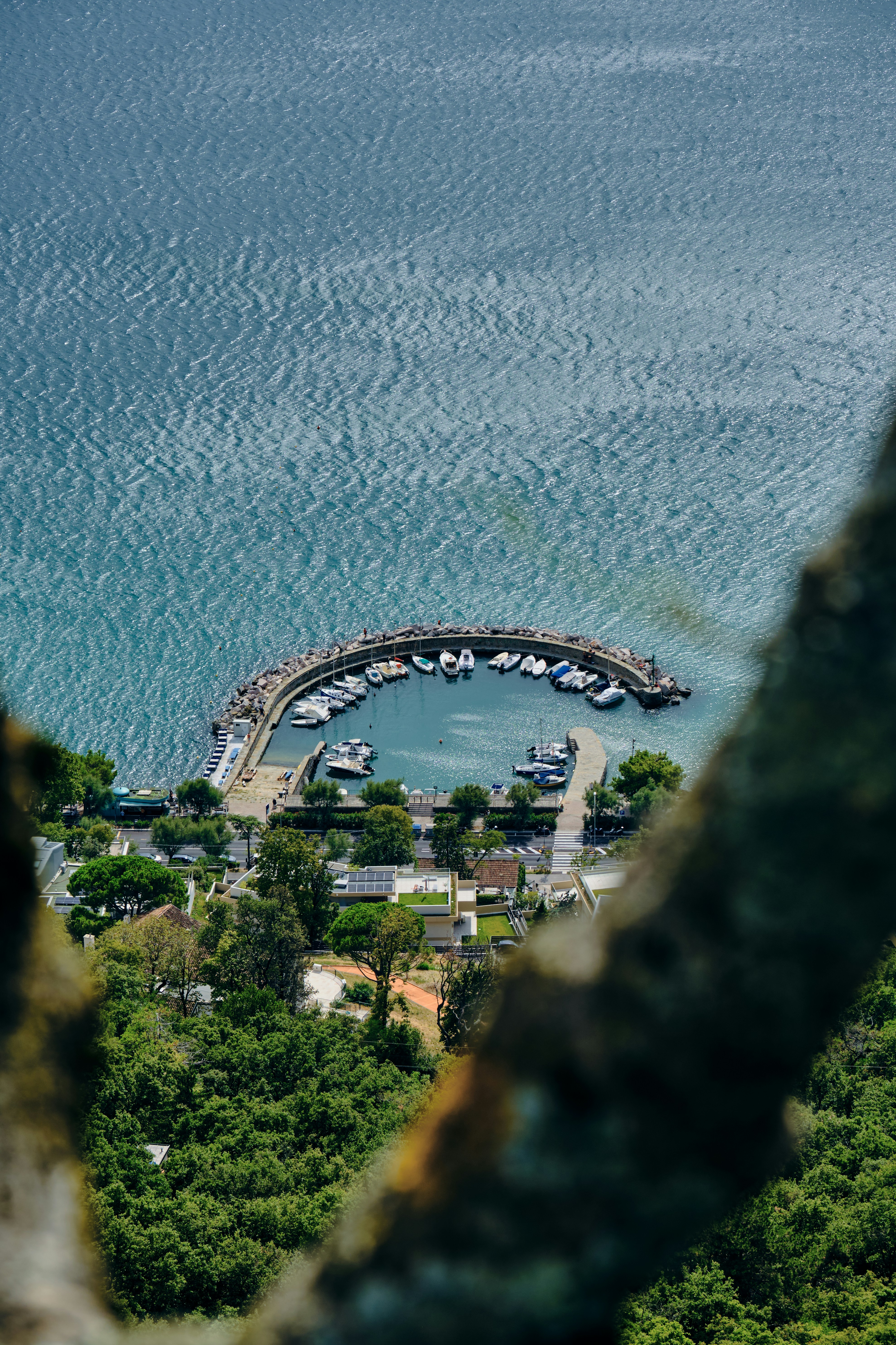 Harbour | Boats docked in a curved harbor seen from above