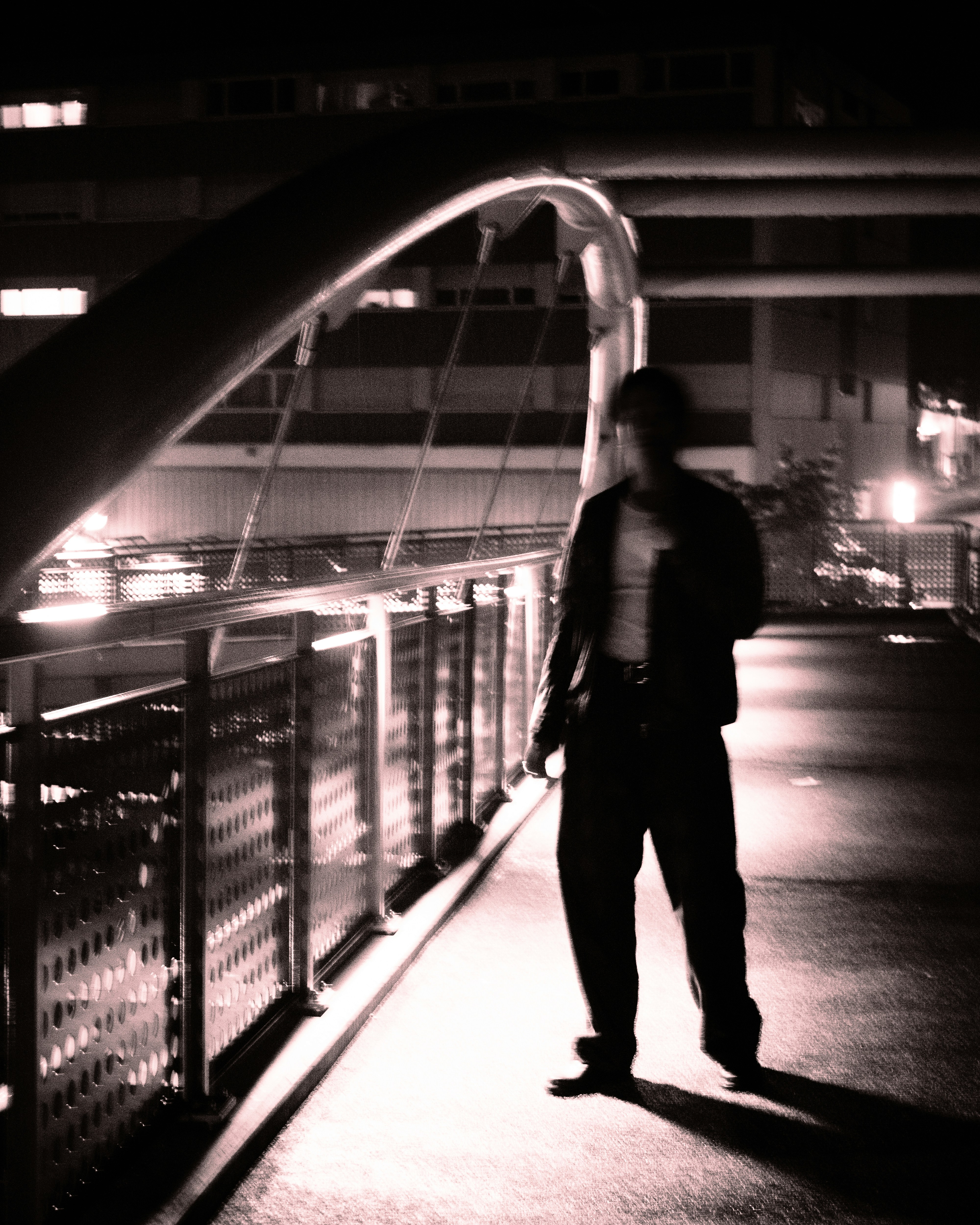 Man standing on a bridge at night photo – Free Portrait Image on Unsplash
