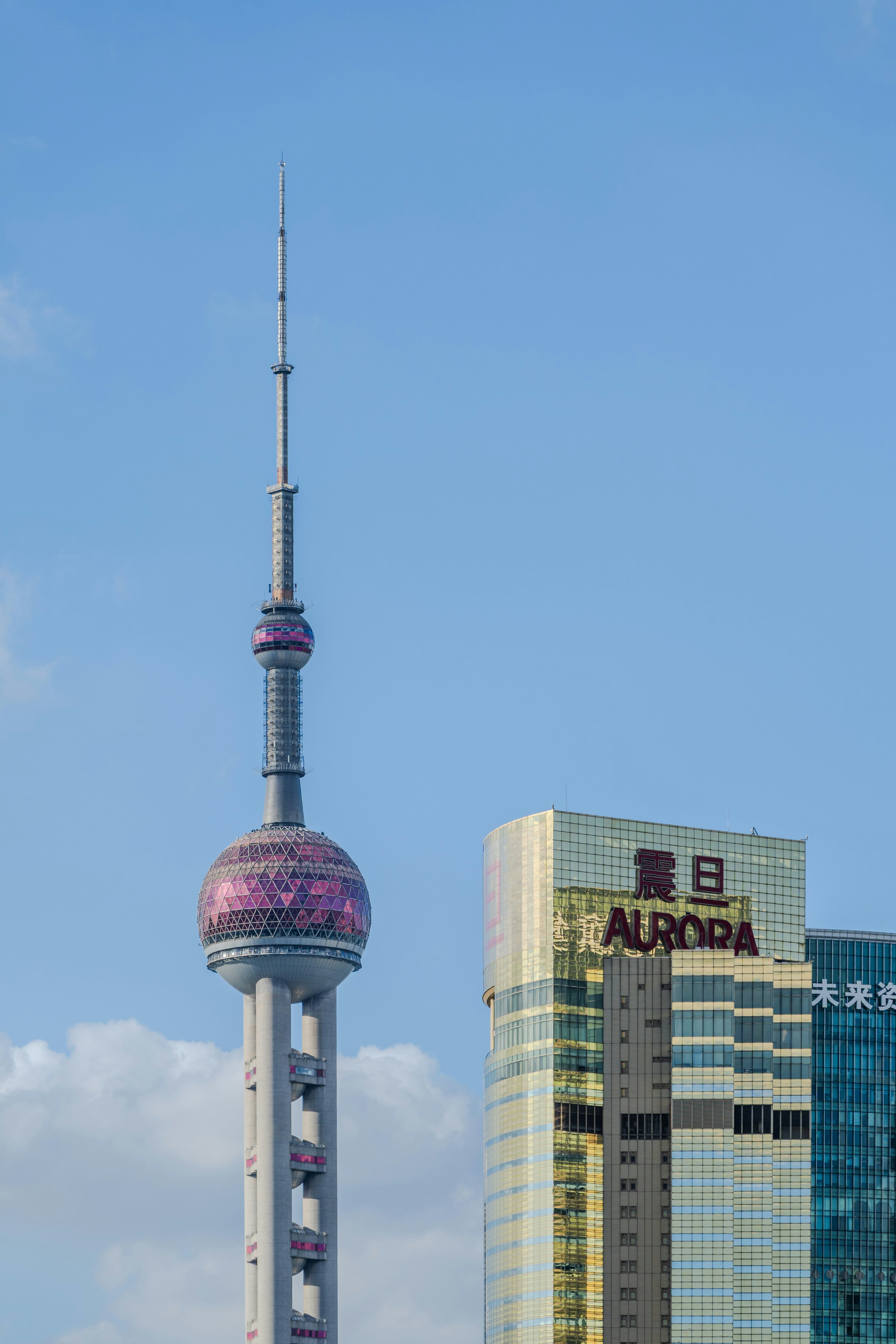 Oriental pearl tower and modern skyscrapers under blue sky