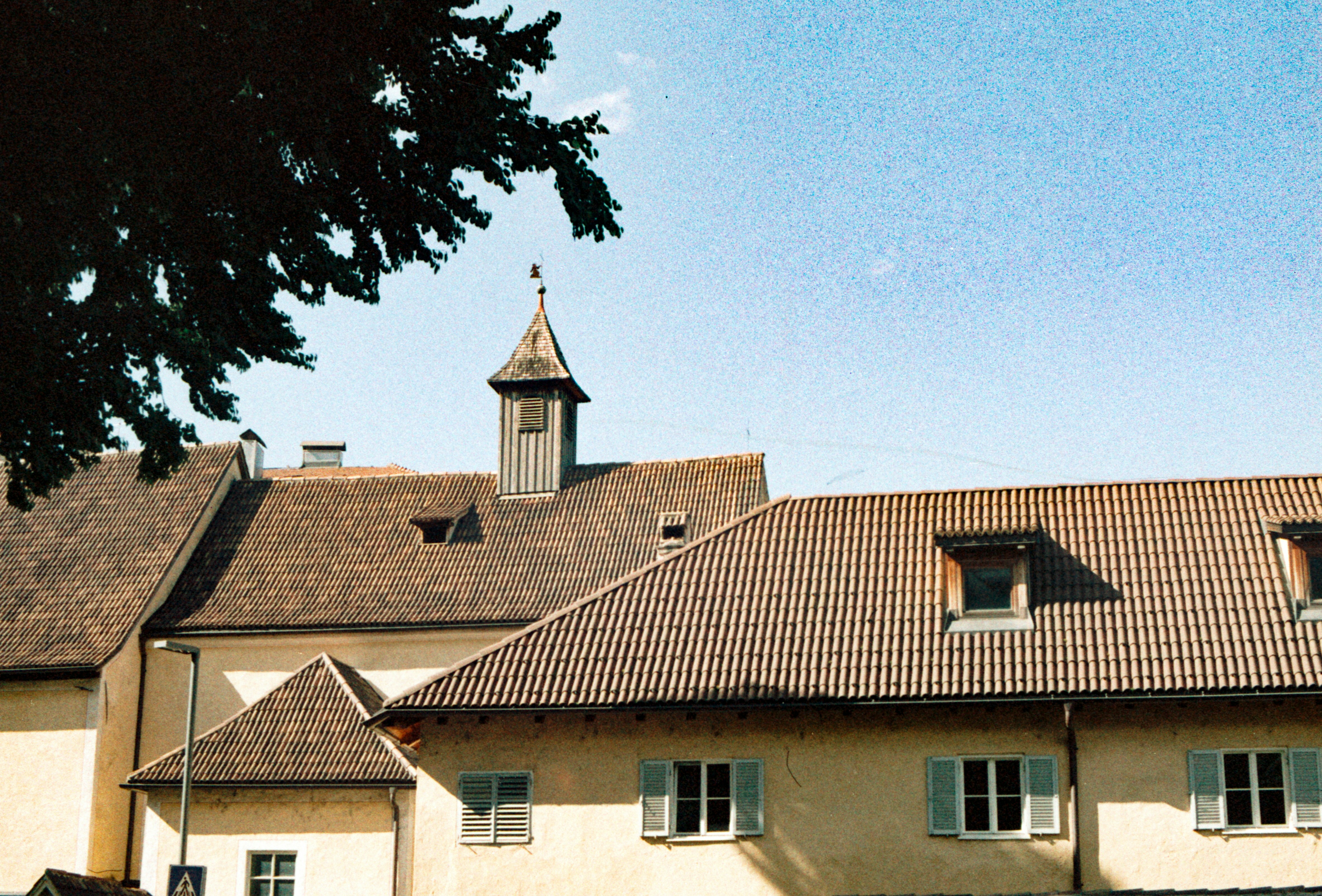 Old european building with tiled roofs and dormer windows