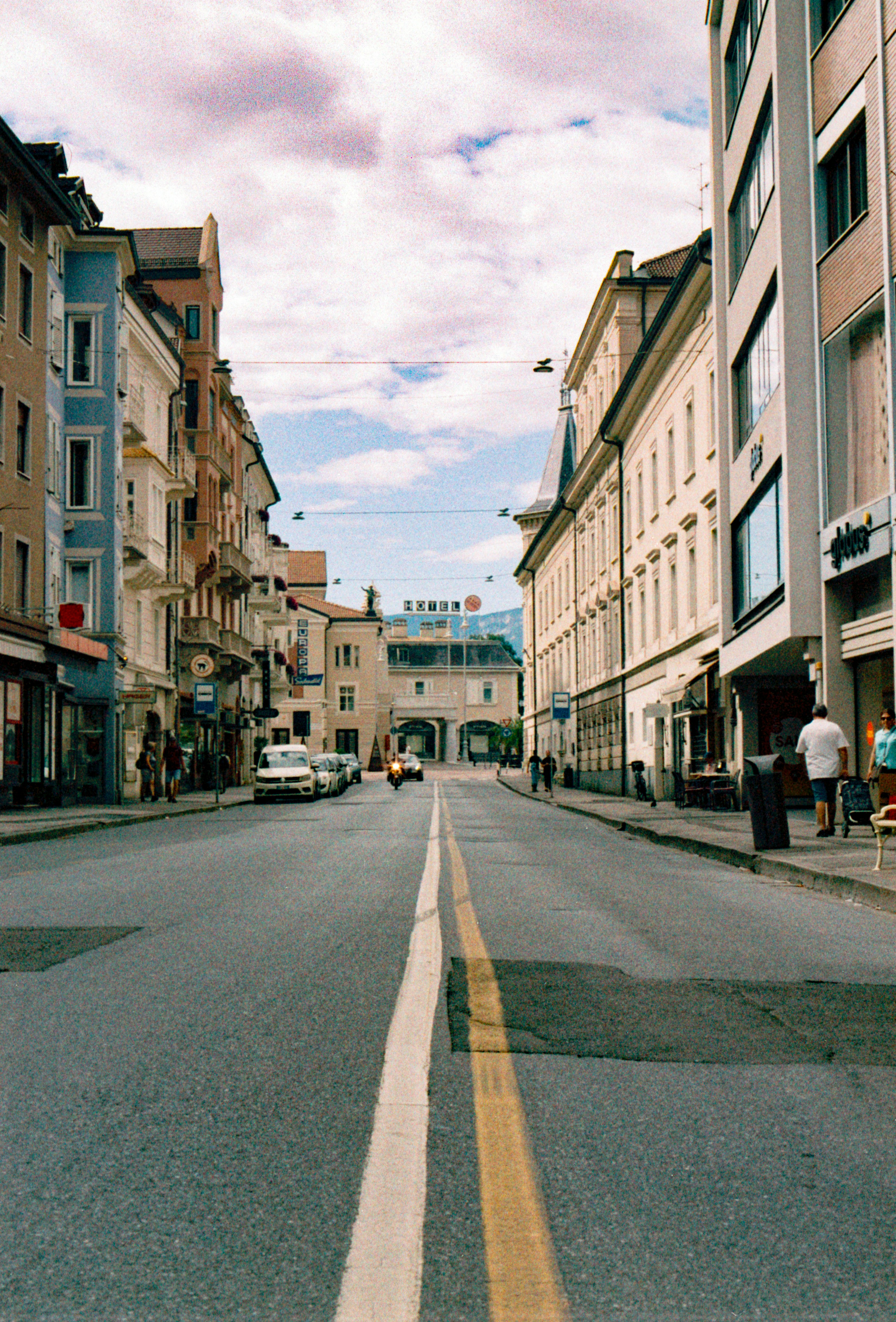 Street view of buildings and cars on a sunny day
