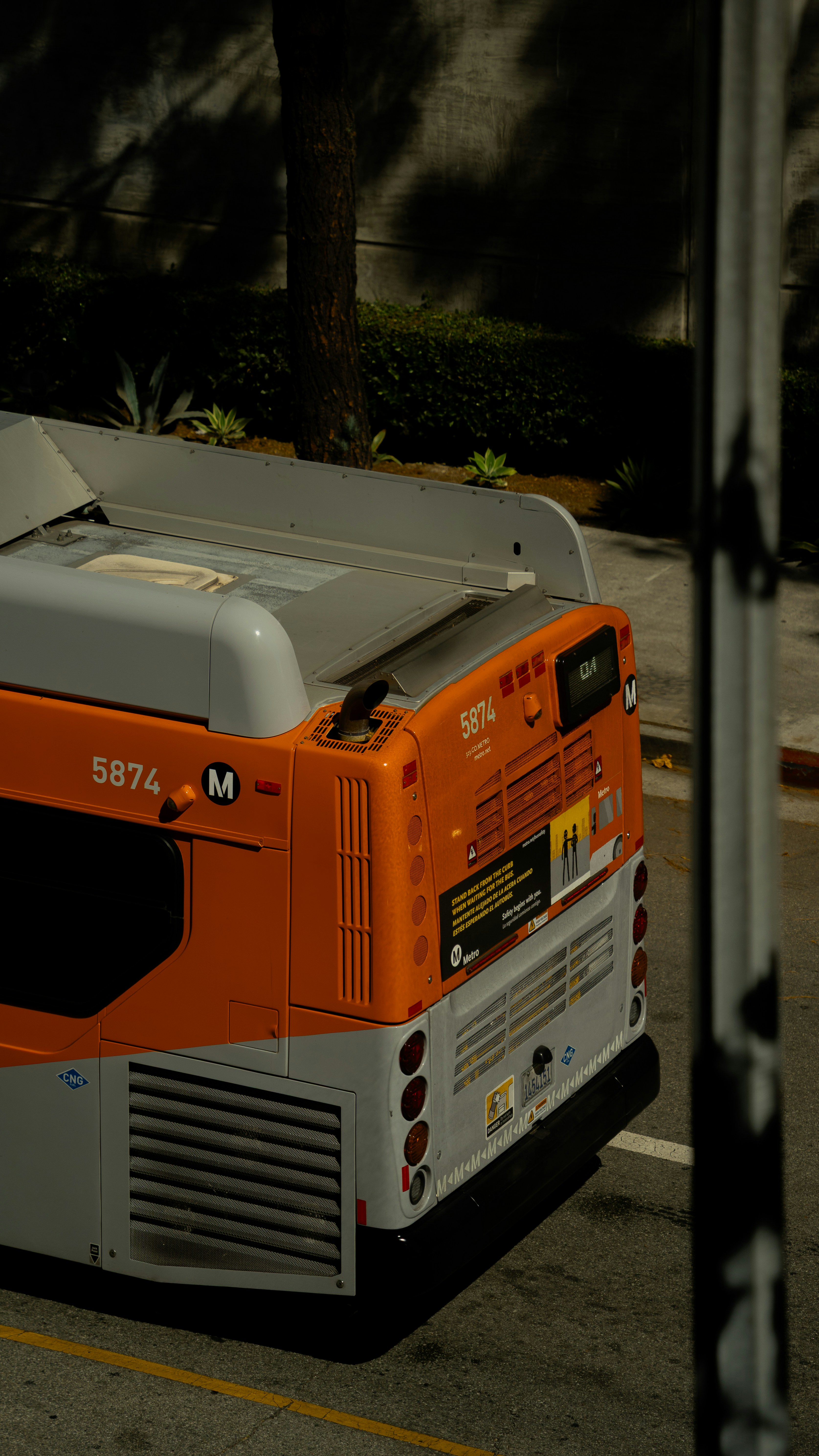 Metro bus in Los Angeles | Orange and gray bus parked on street