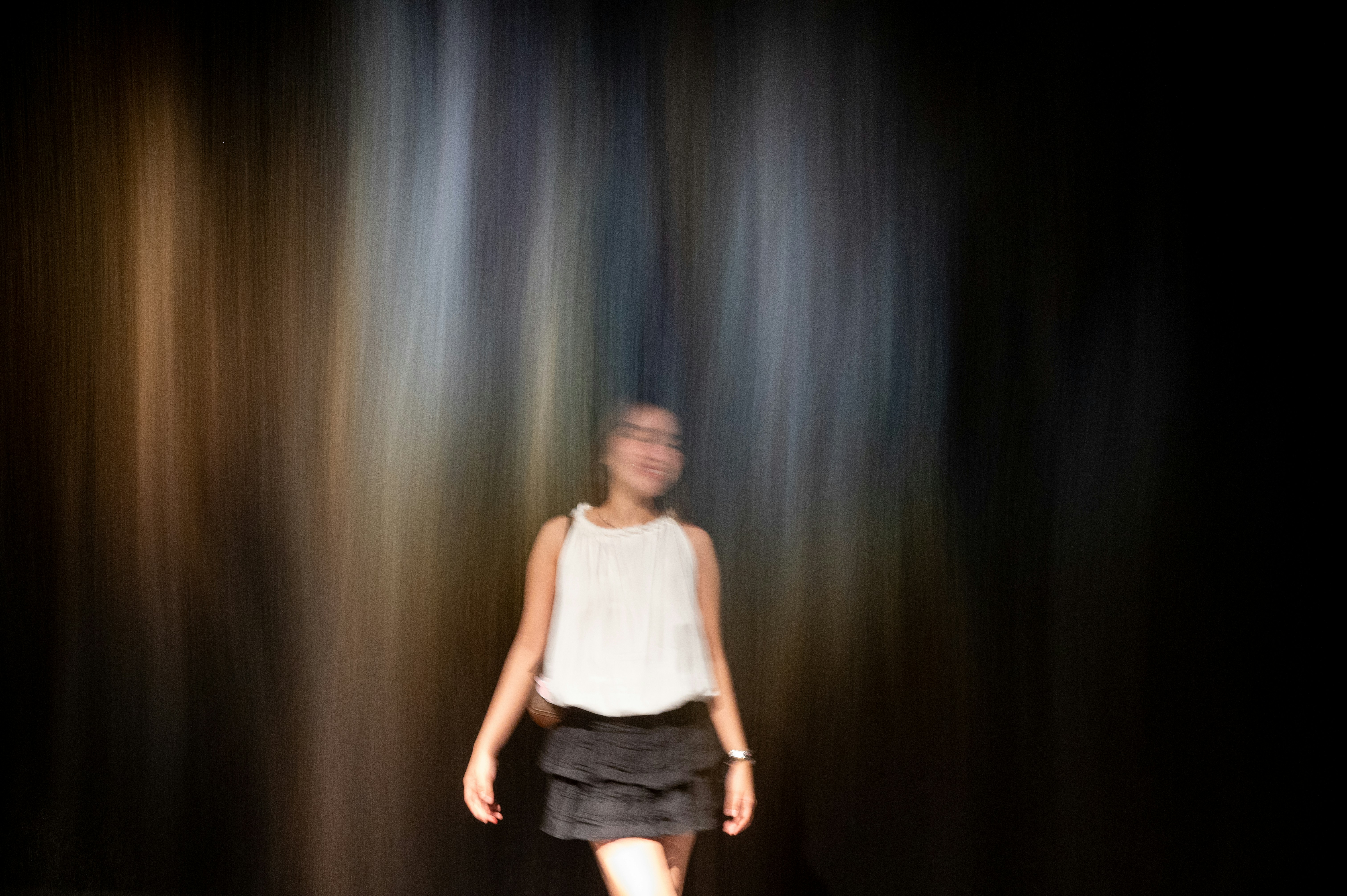 Woman walking with blurred background streaks