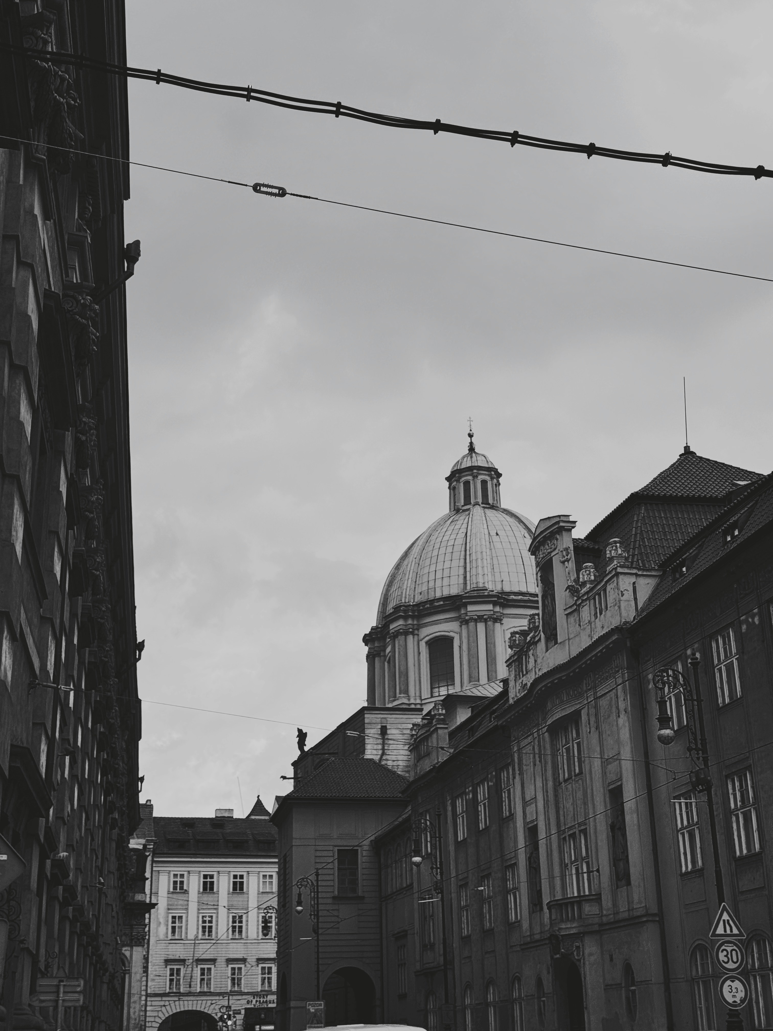 Historic european street with a prominent dome building.
