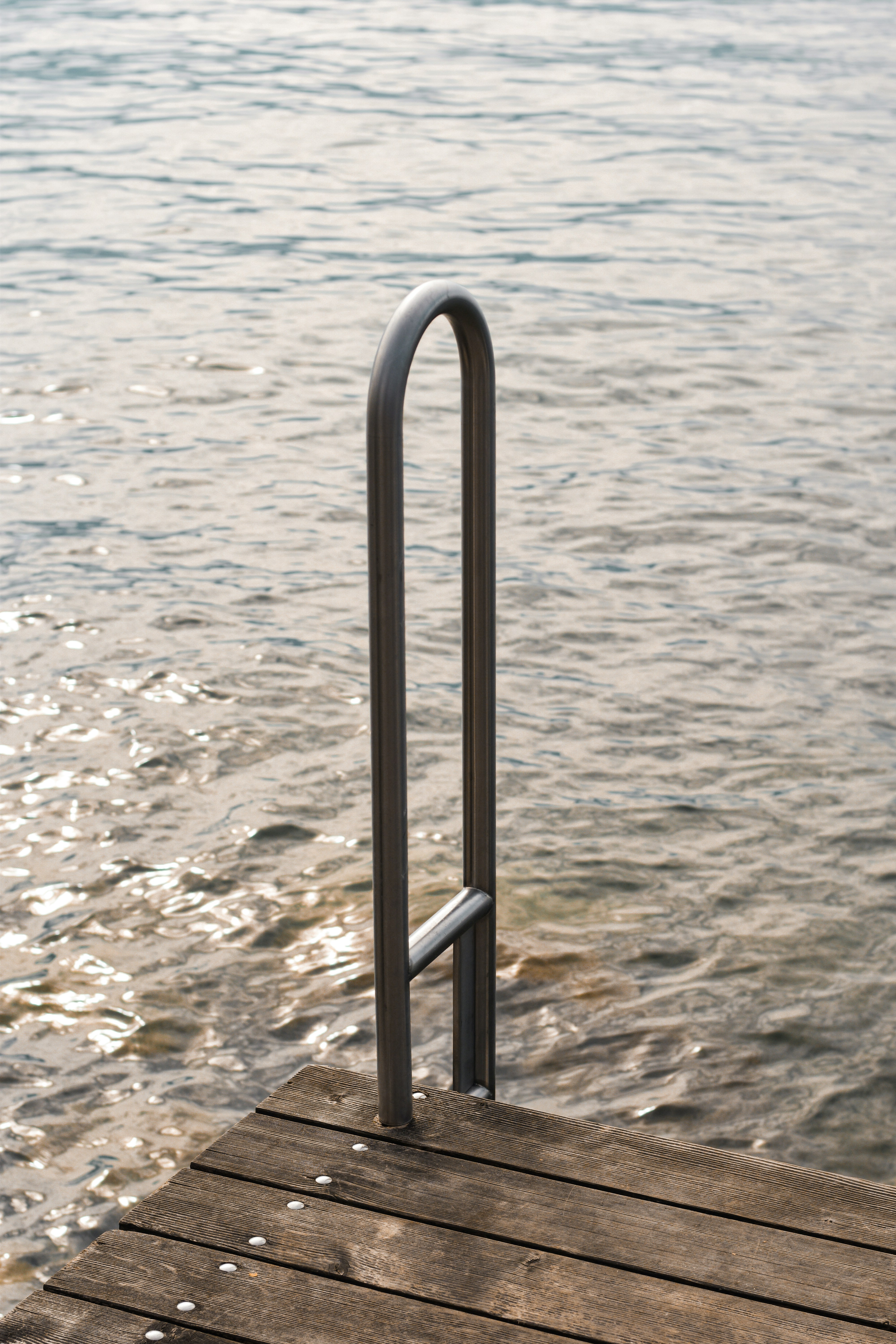 Metal Archway over Lake: A Quiet Dock Reaches into the Water