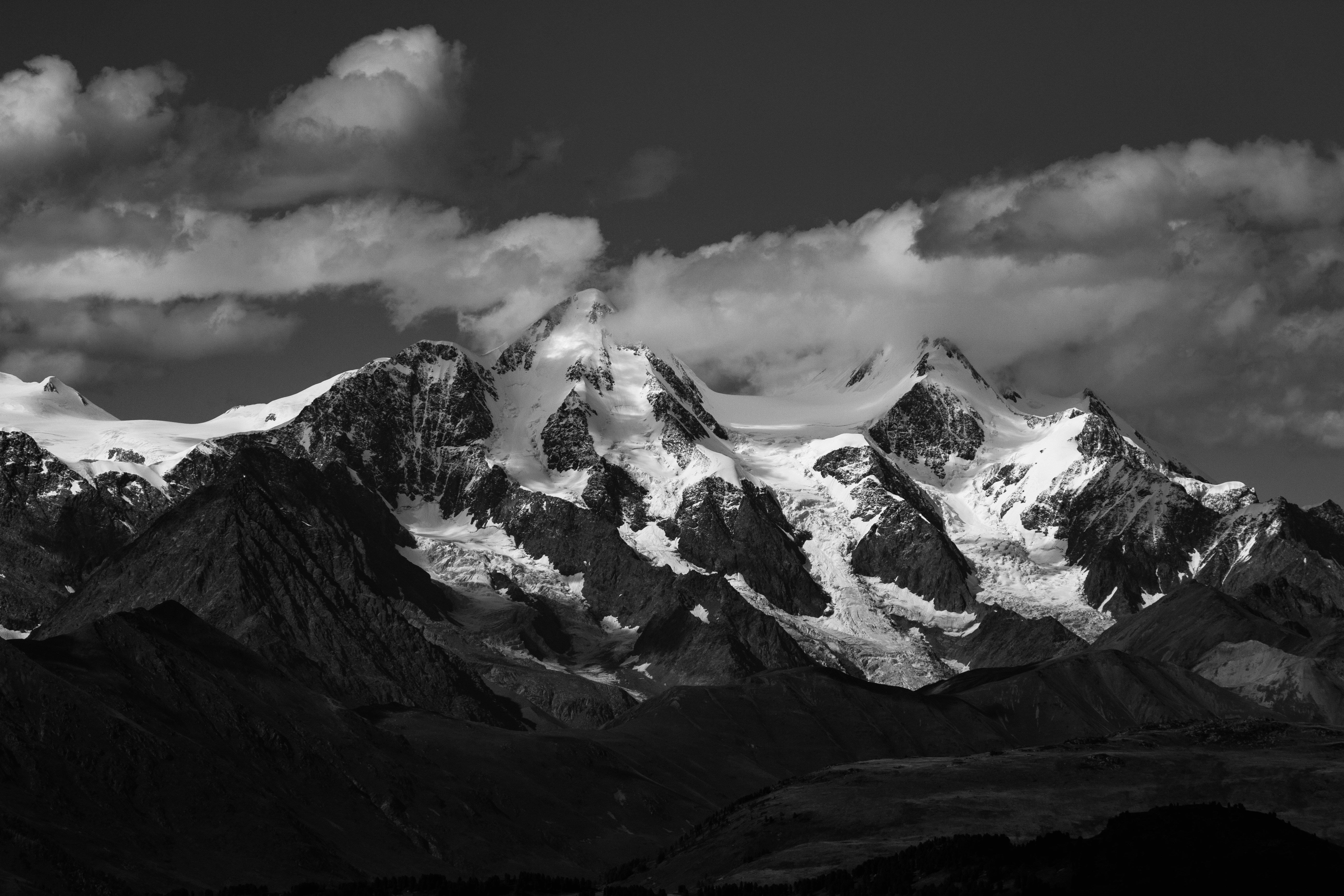 Majestic Peaks Amidst Whispering Clouds