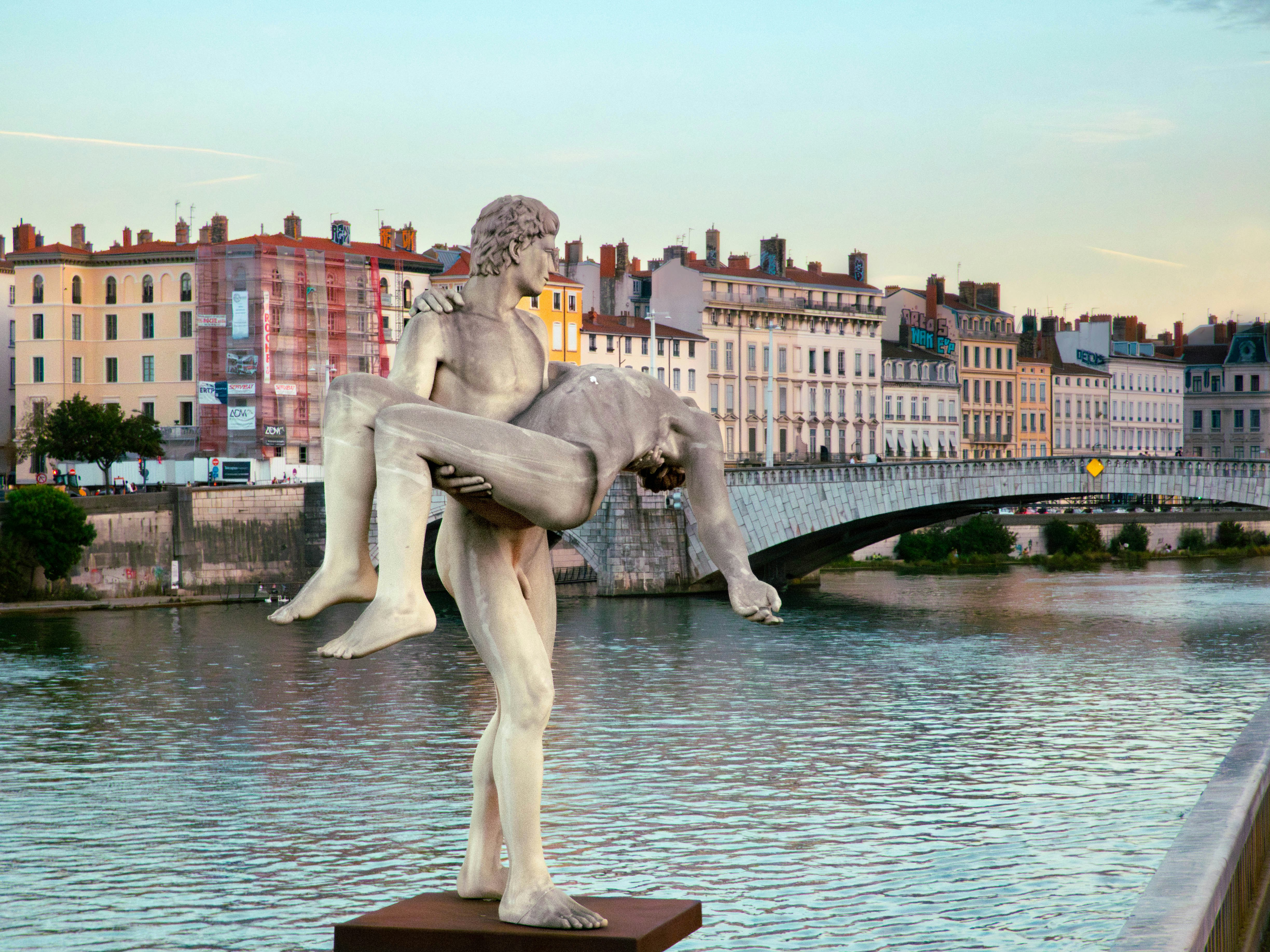 Stone Atlas by the River: A Balancing Gesture Over Water