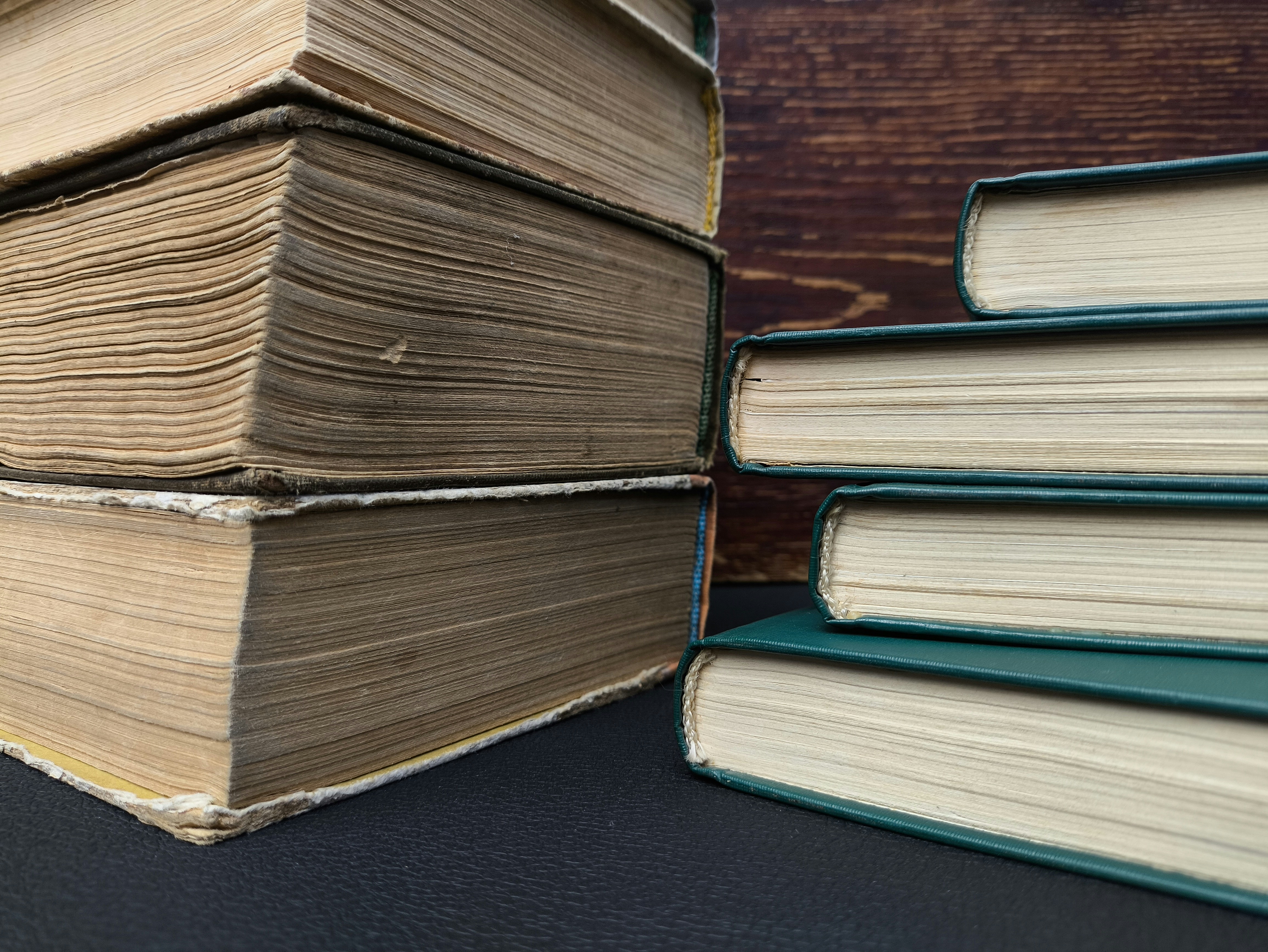 Stack of old books next to modern books