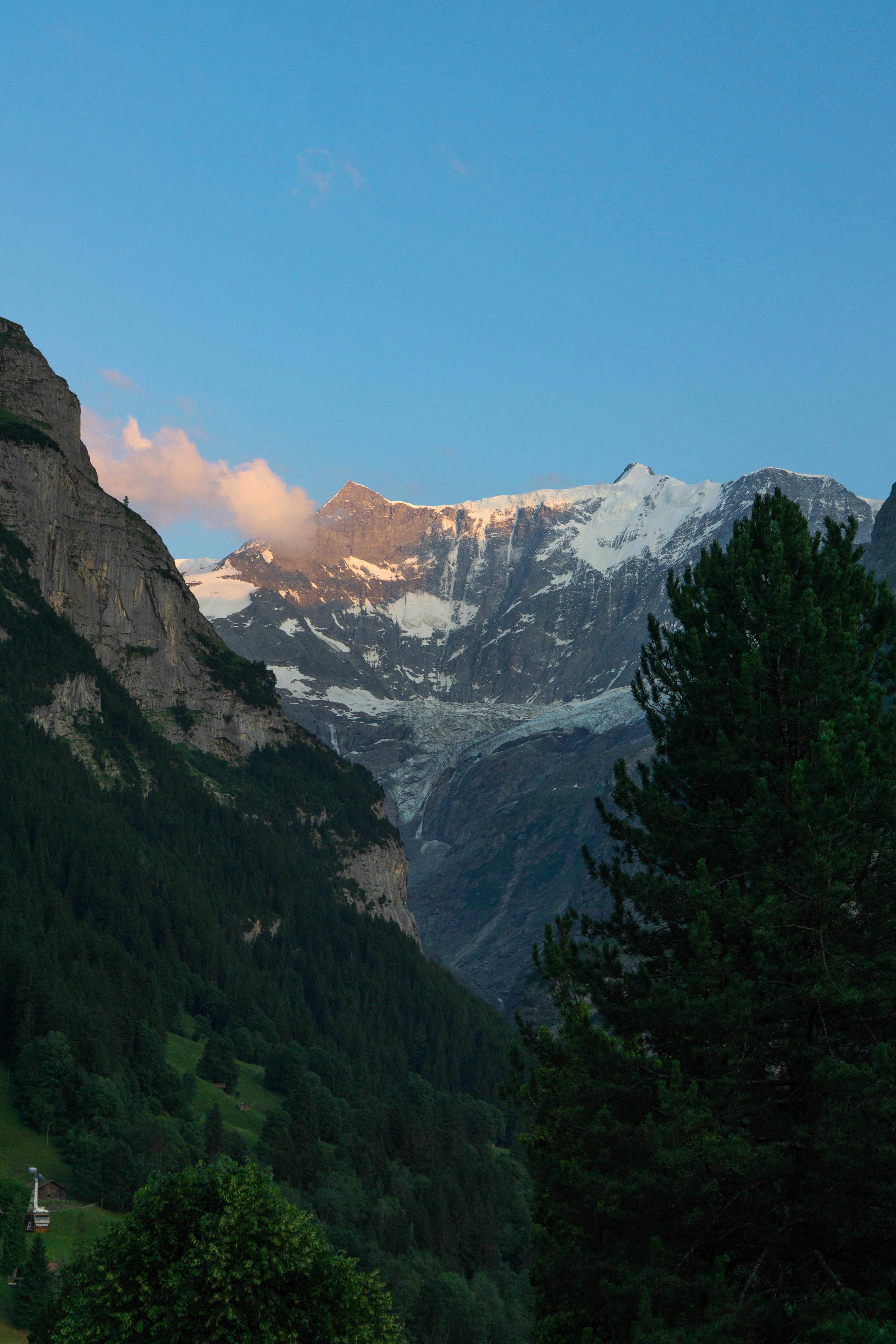 View from Grindelwald, Switzerland. Summer 2025 | Snow-capped mountains illuminated by the setting sun.