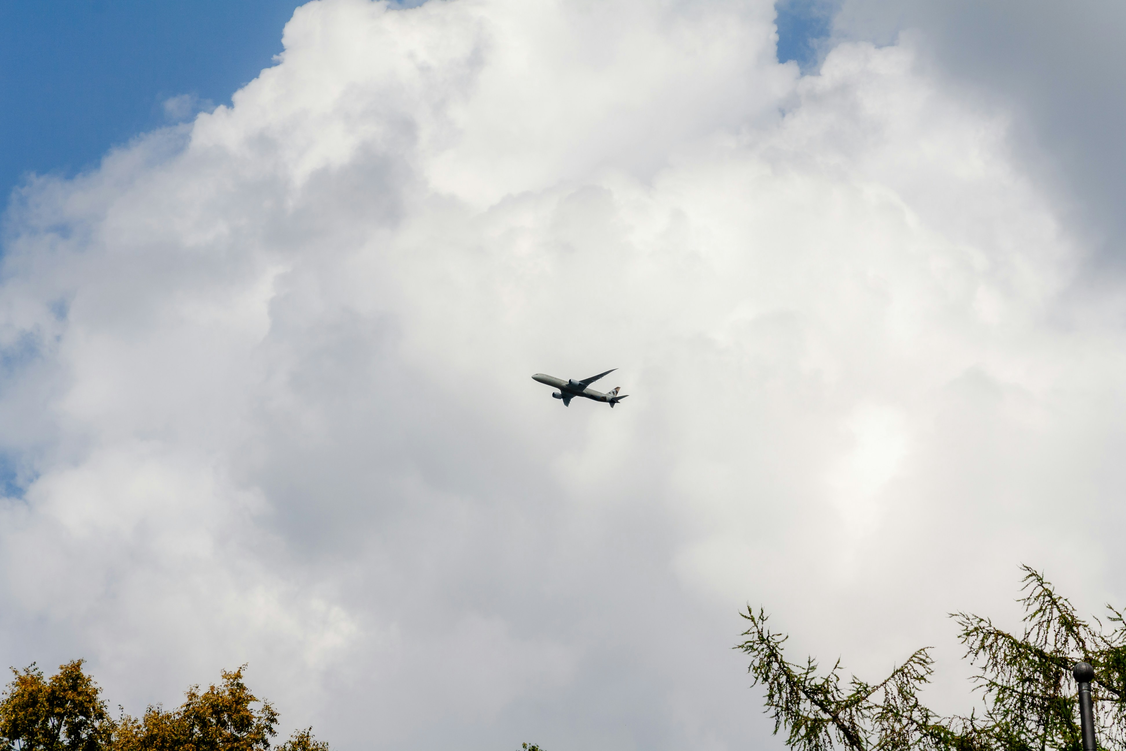 Airplane flying through cloudy sky