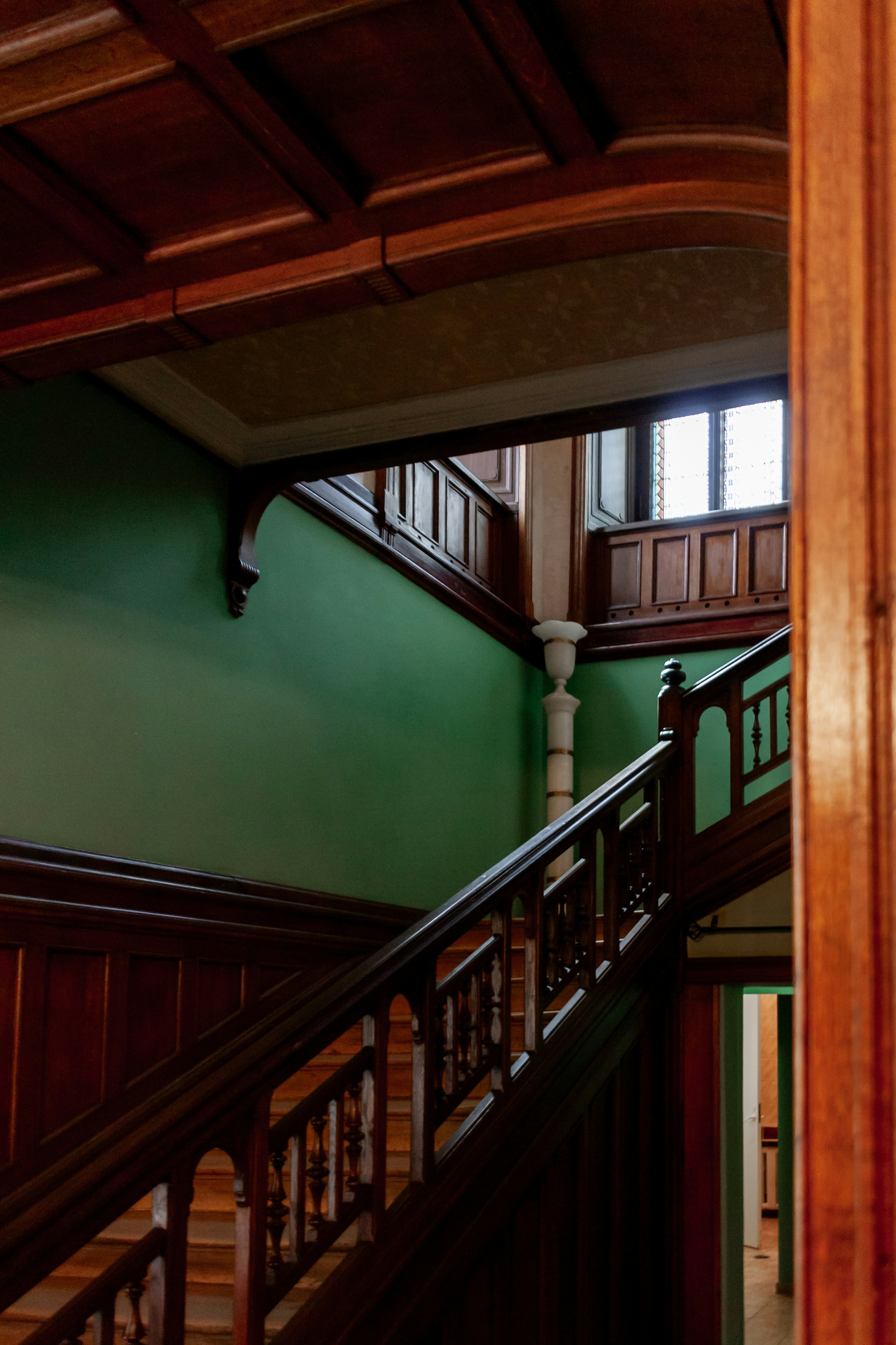 Wooden staircase with green walls in an old building