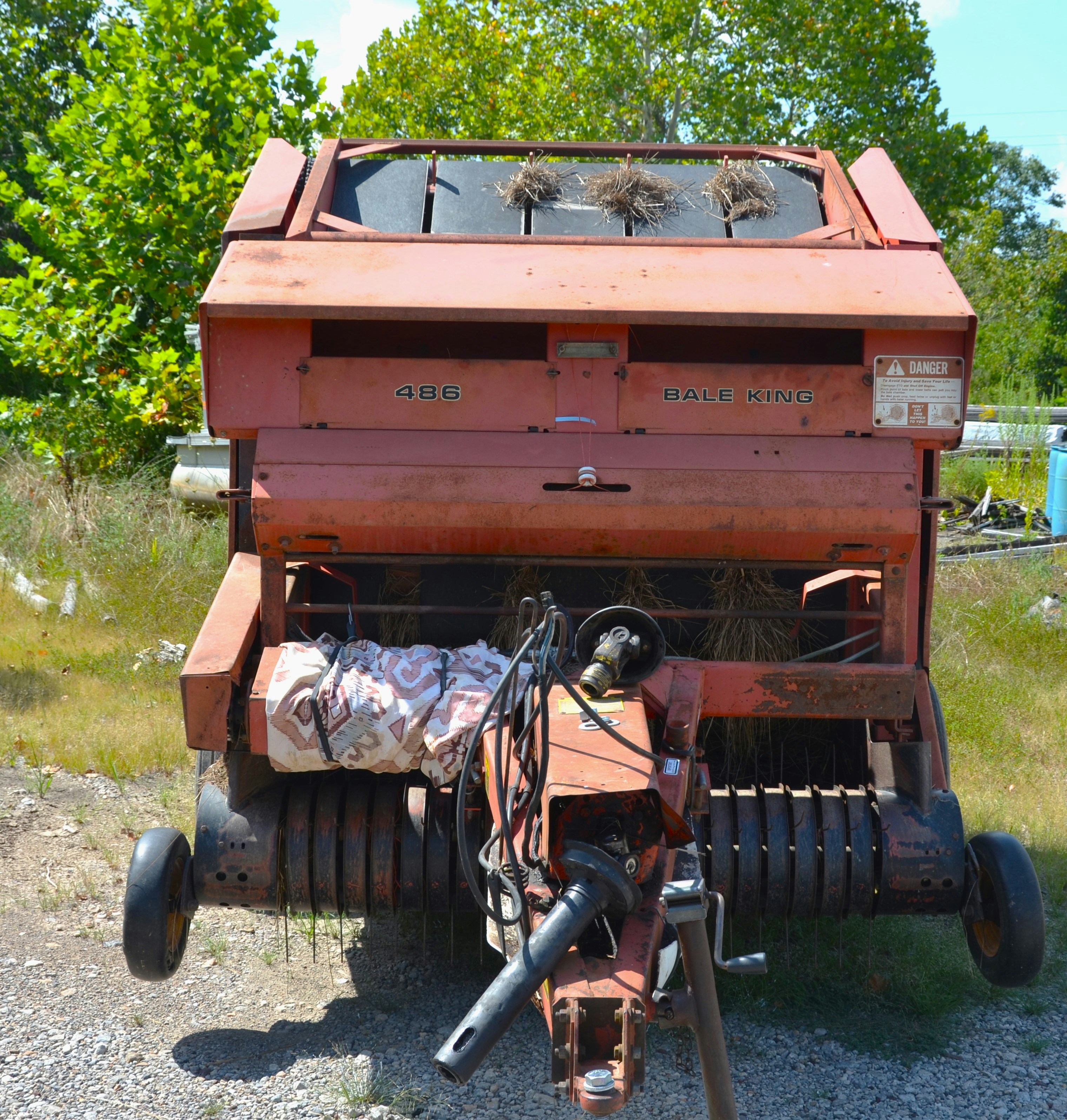 Rustic Resilience: The Bale King 486 in Nature's Embrace