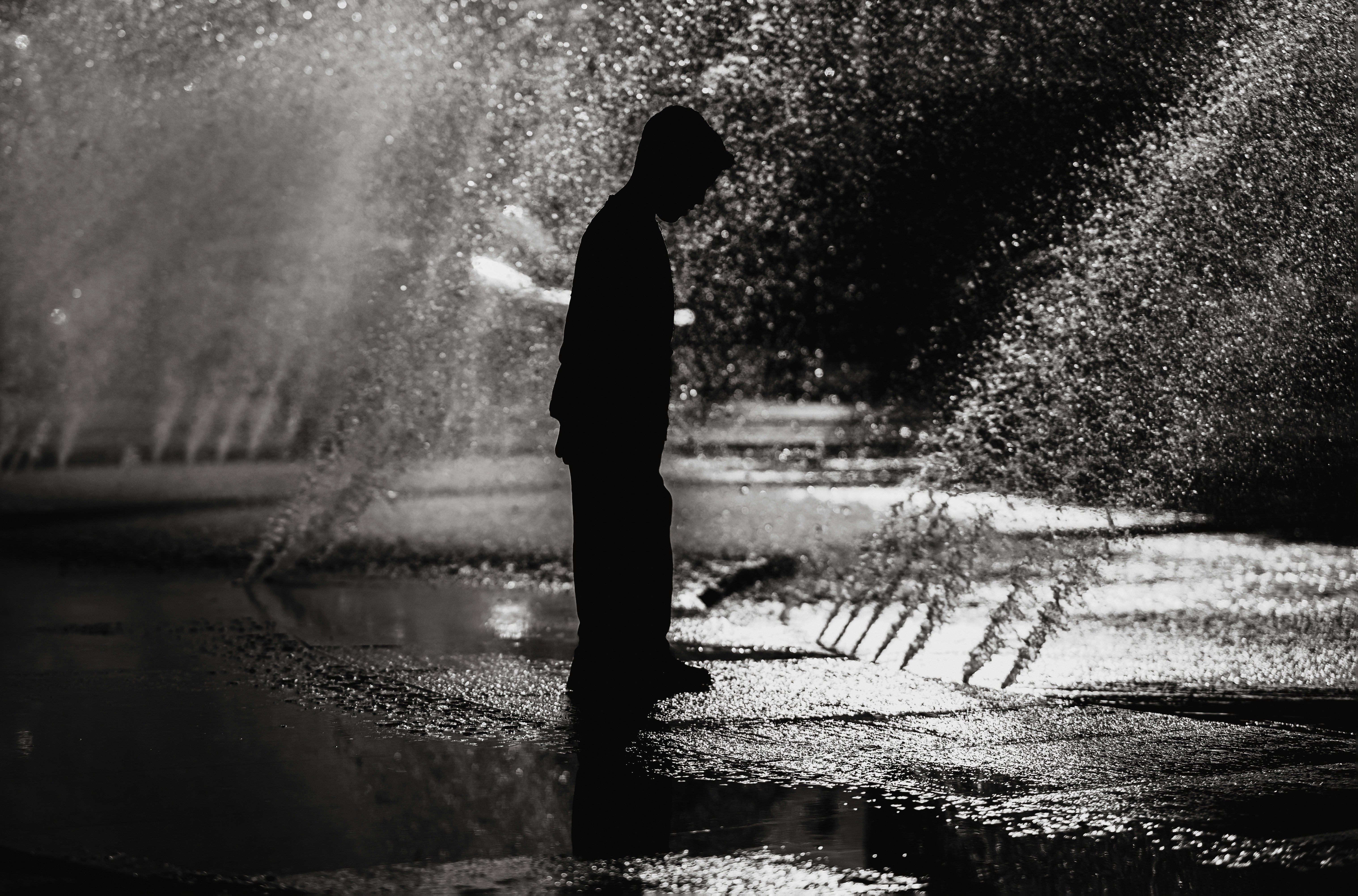 Silhouette of a man standing in the rain