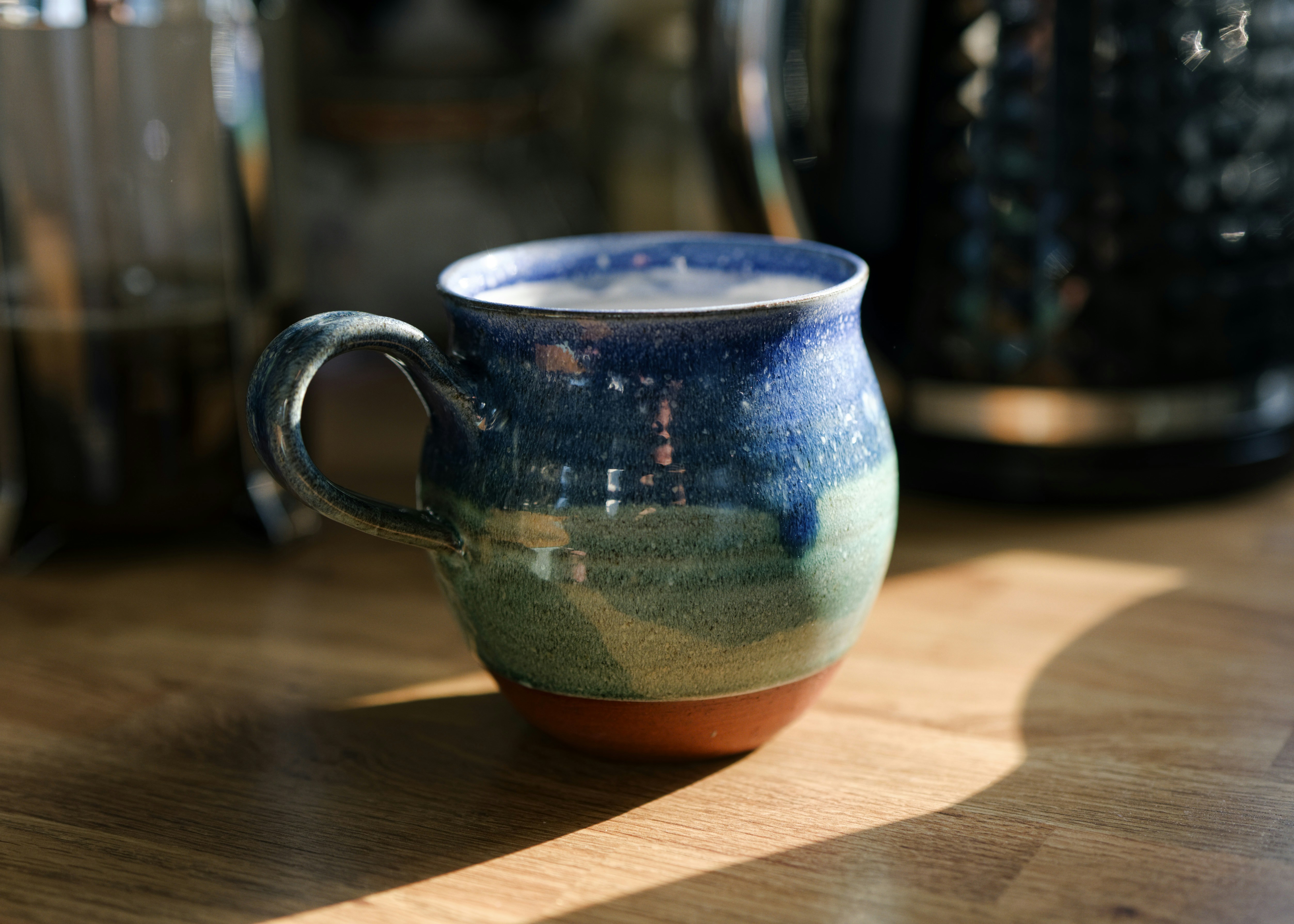 Hand crafted mug | A colorful ceramic mug filled with a beverage.