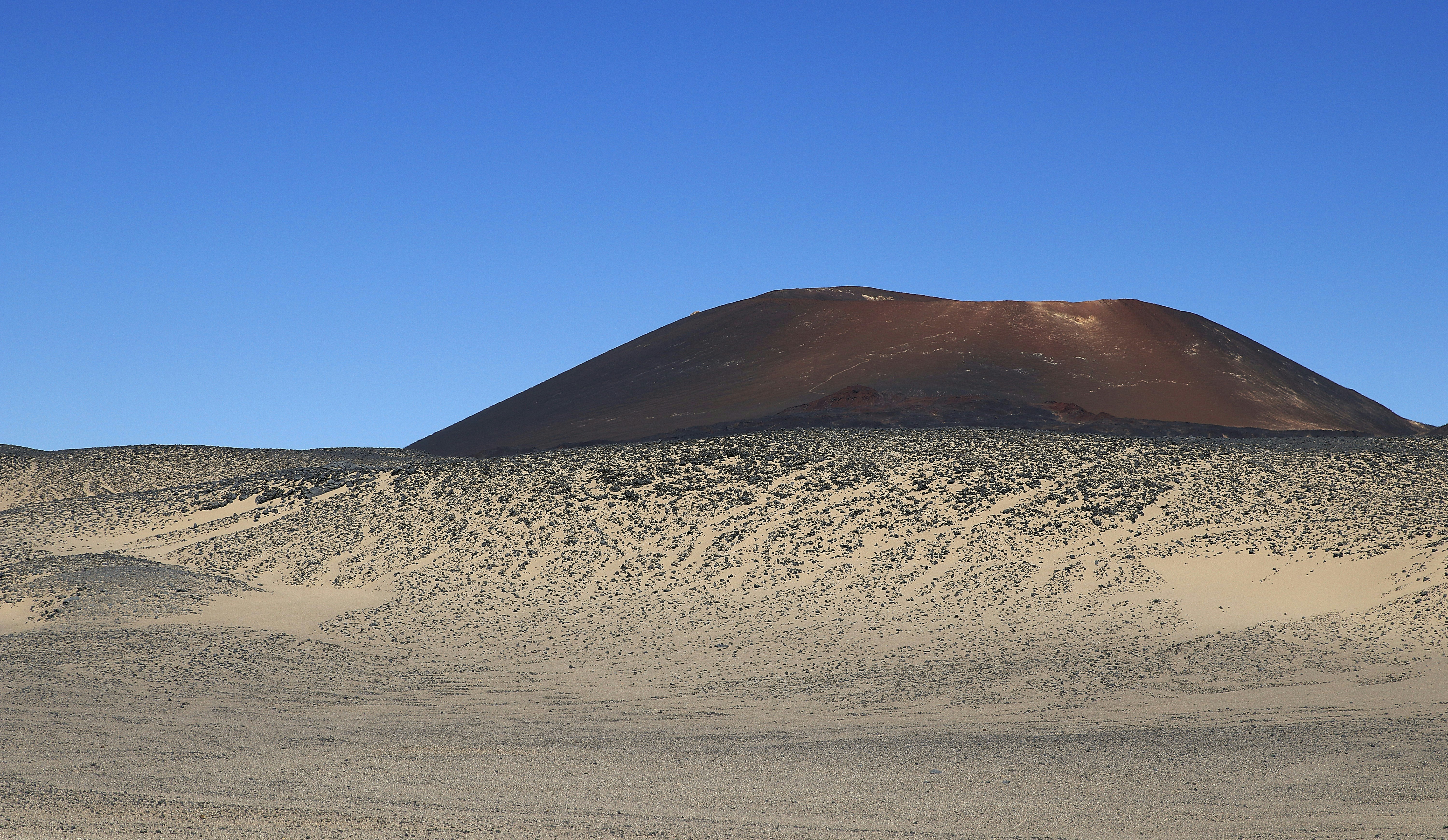 Volcano crater under a clear blue sky