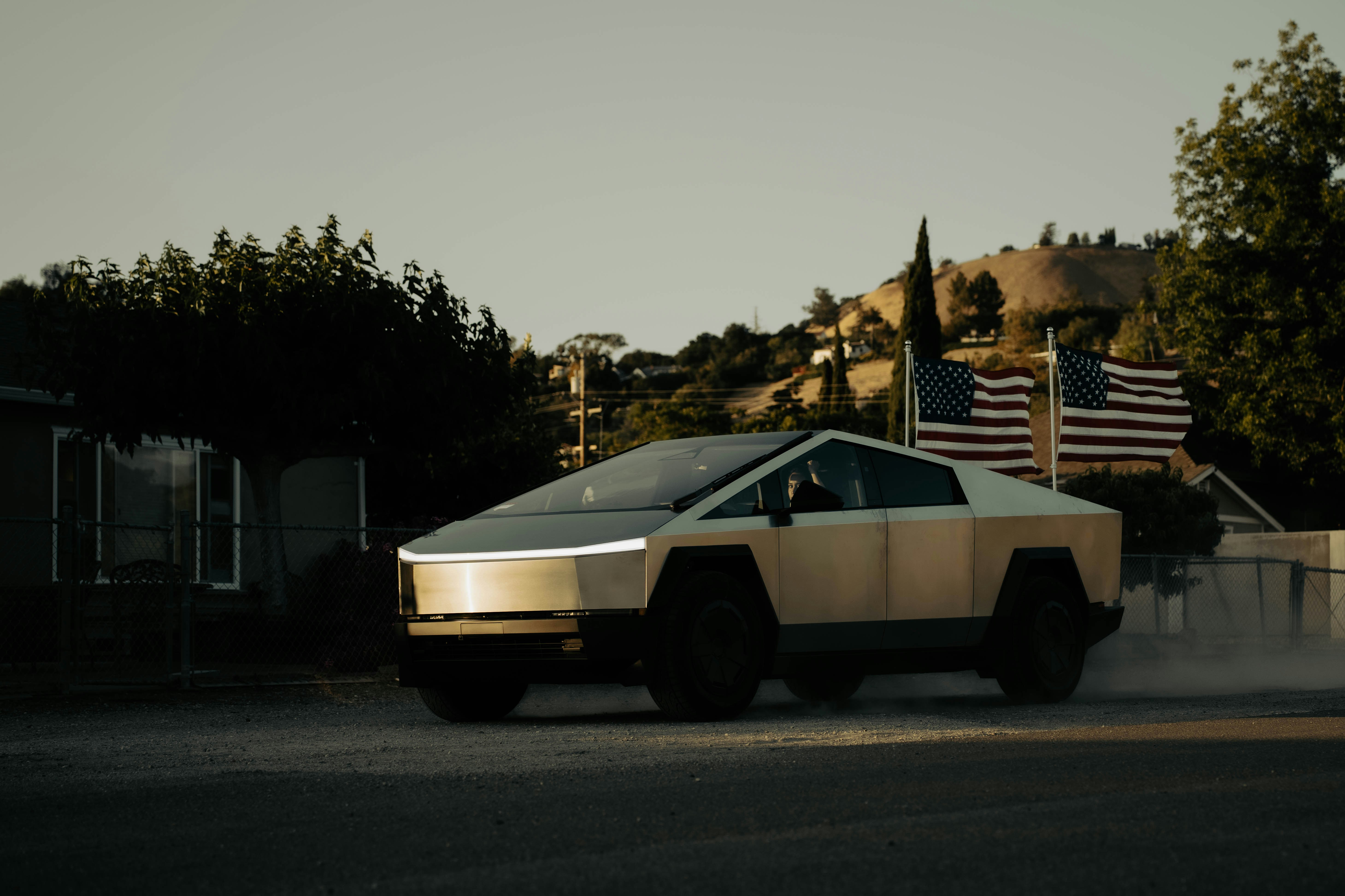 Futuristic truck drives on a dusty road