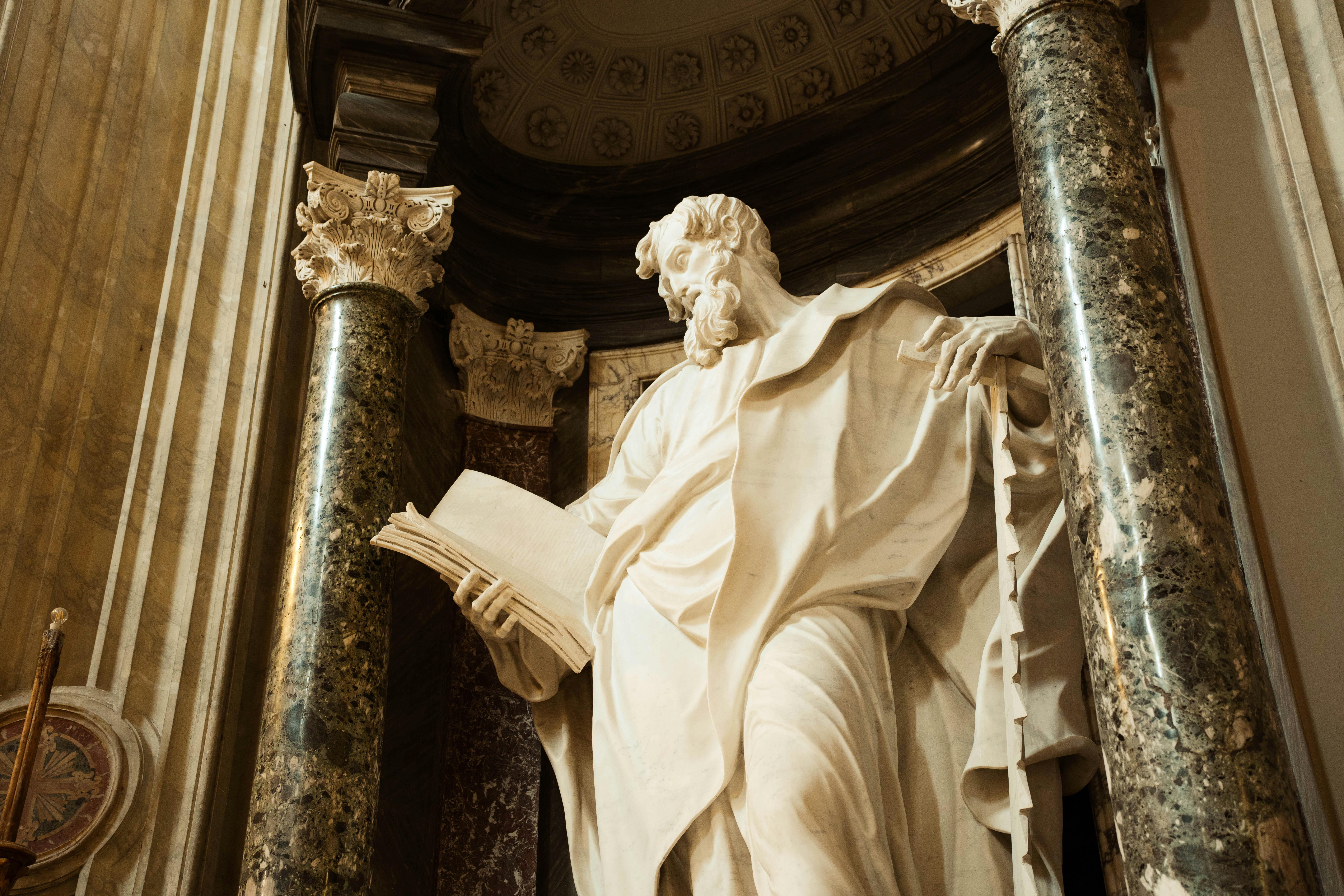 Marble statue of a man holding a book