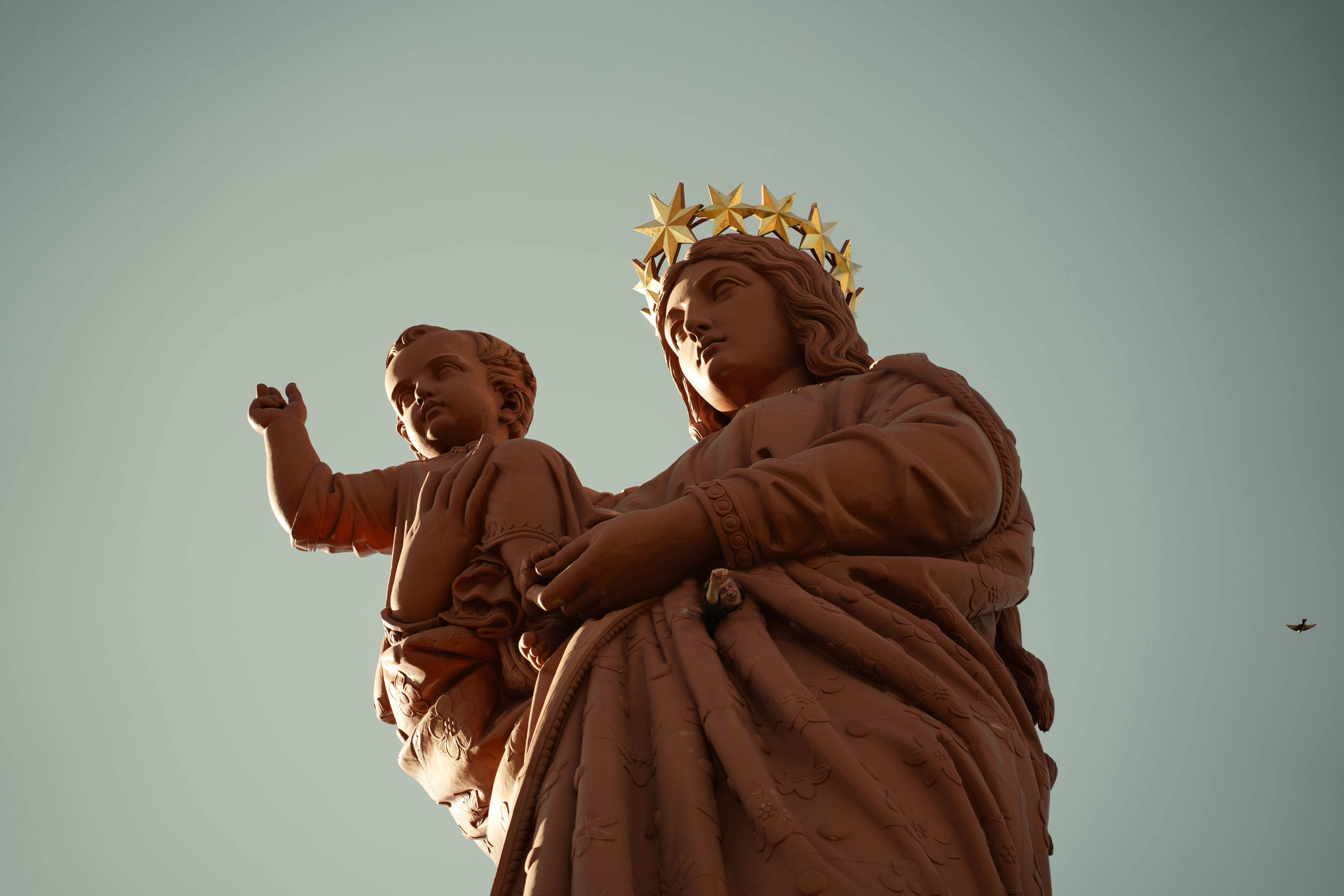Statue of mary holding baby jesus with starry crown