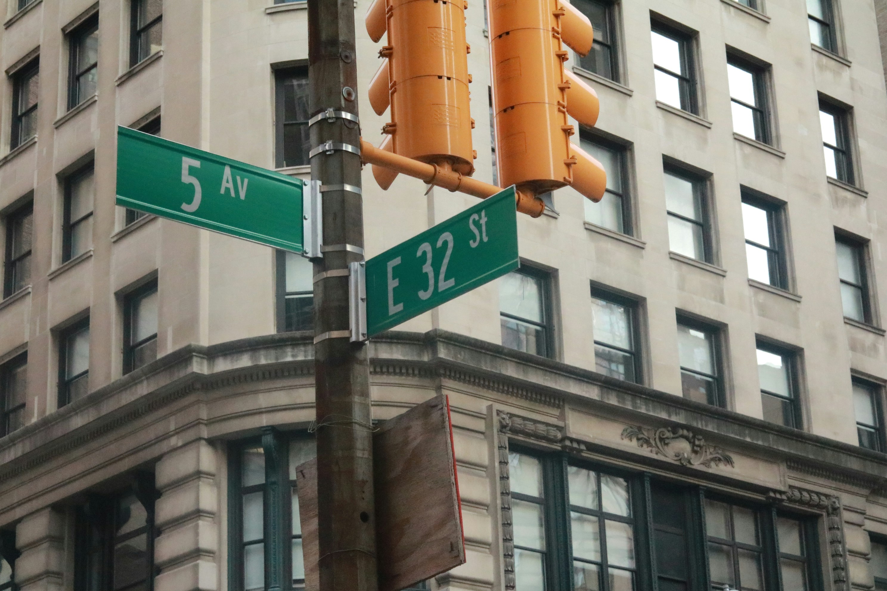 Street signs for 5th avenue and east 32nd street.