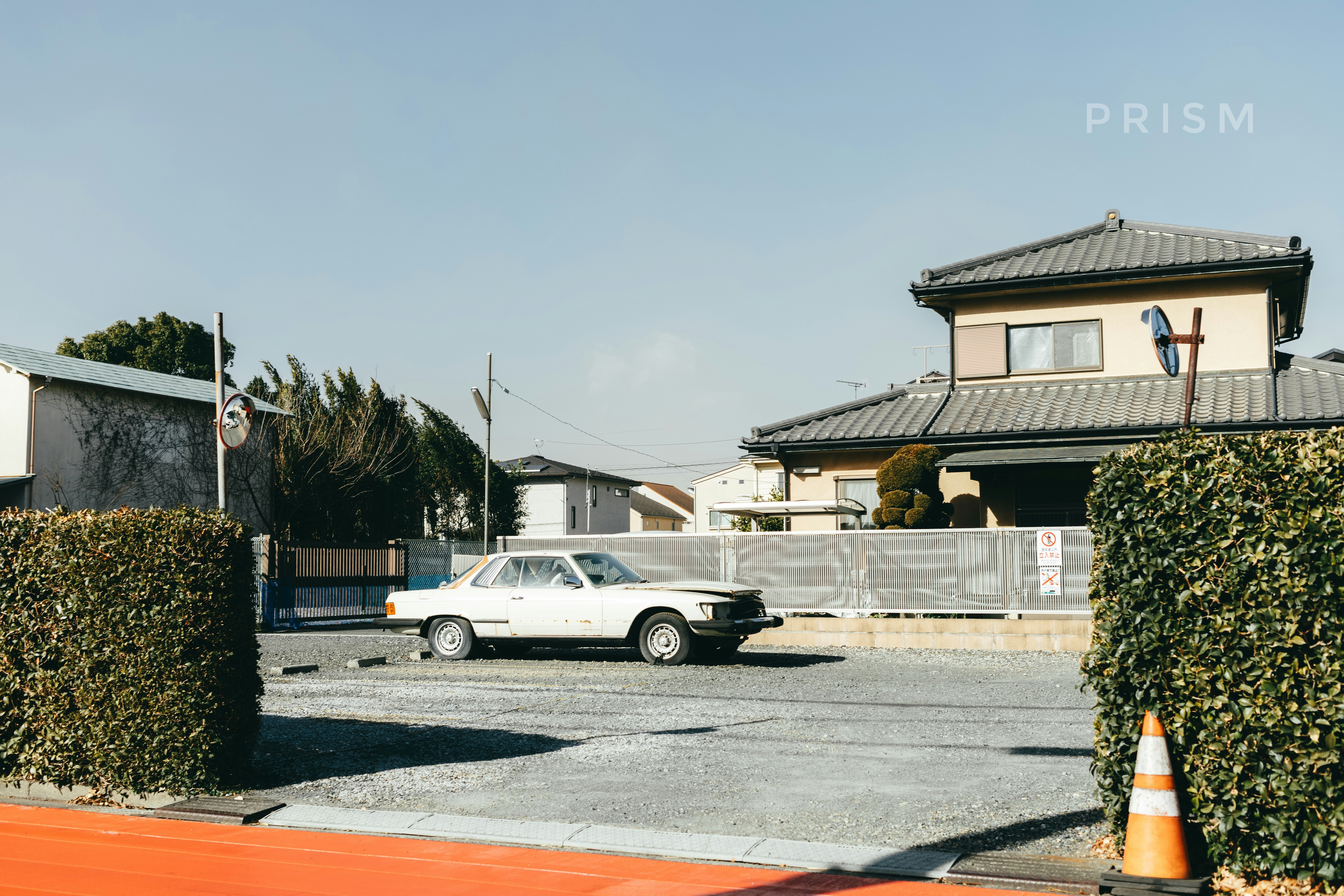 Quiet Parking Lot, Suburban House, and Vintage Car Under Clear Sky