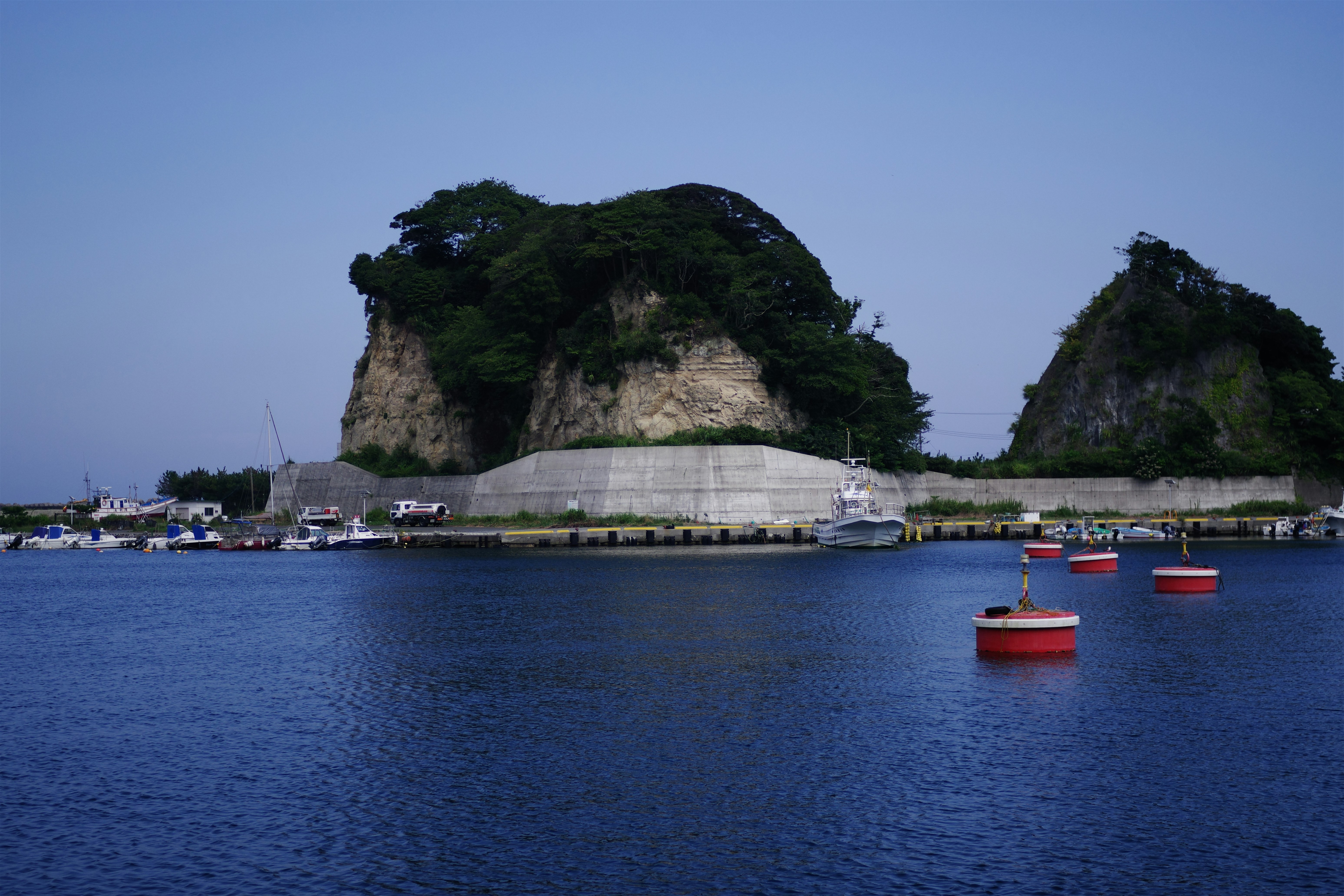 Rocky islands with lush trees and a harbor
