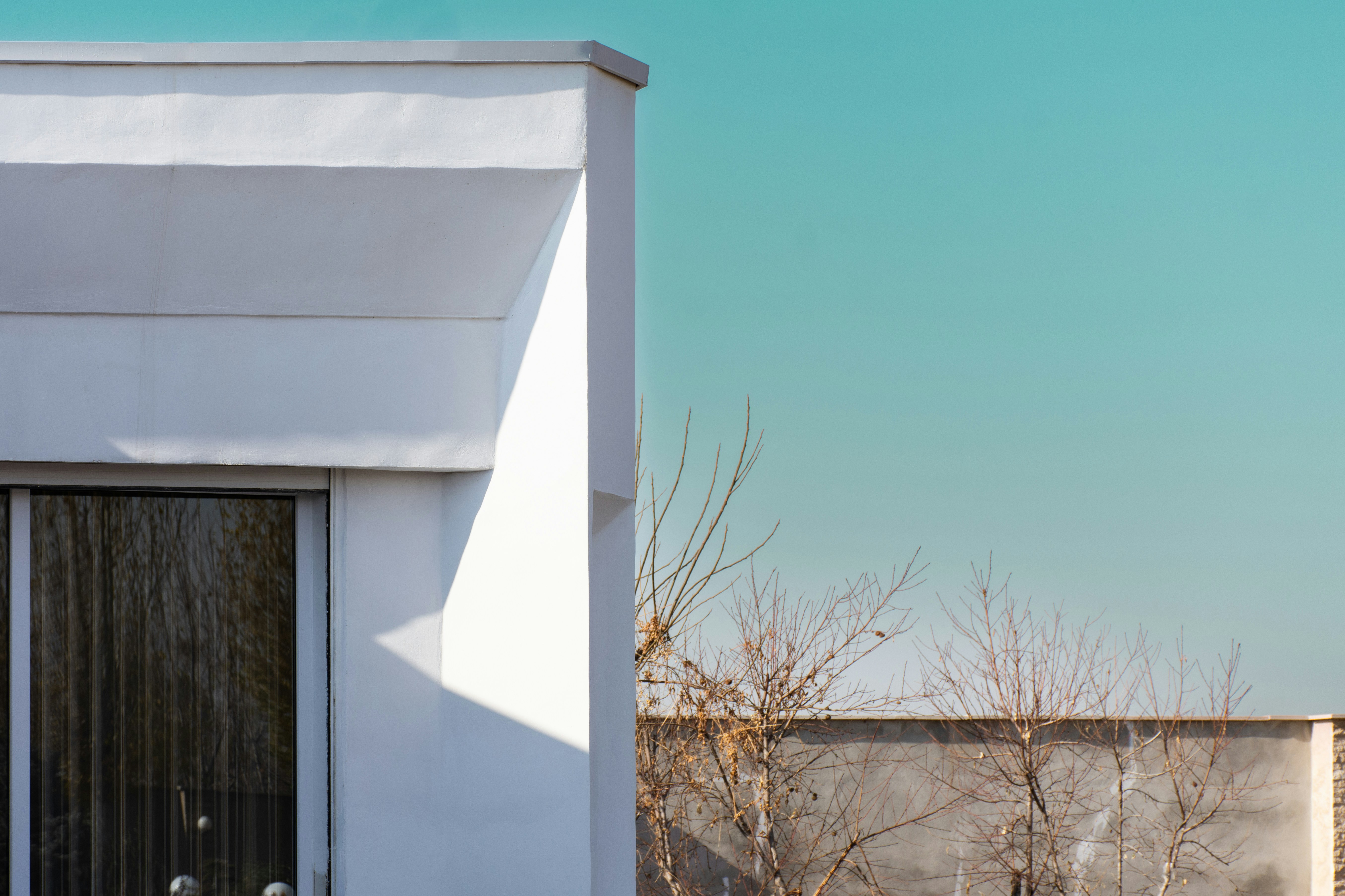 Modern white building against a teal sky