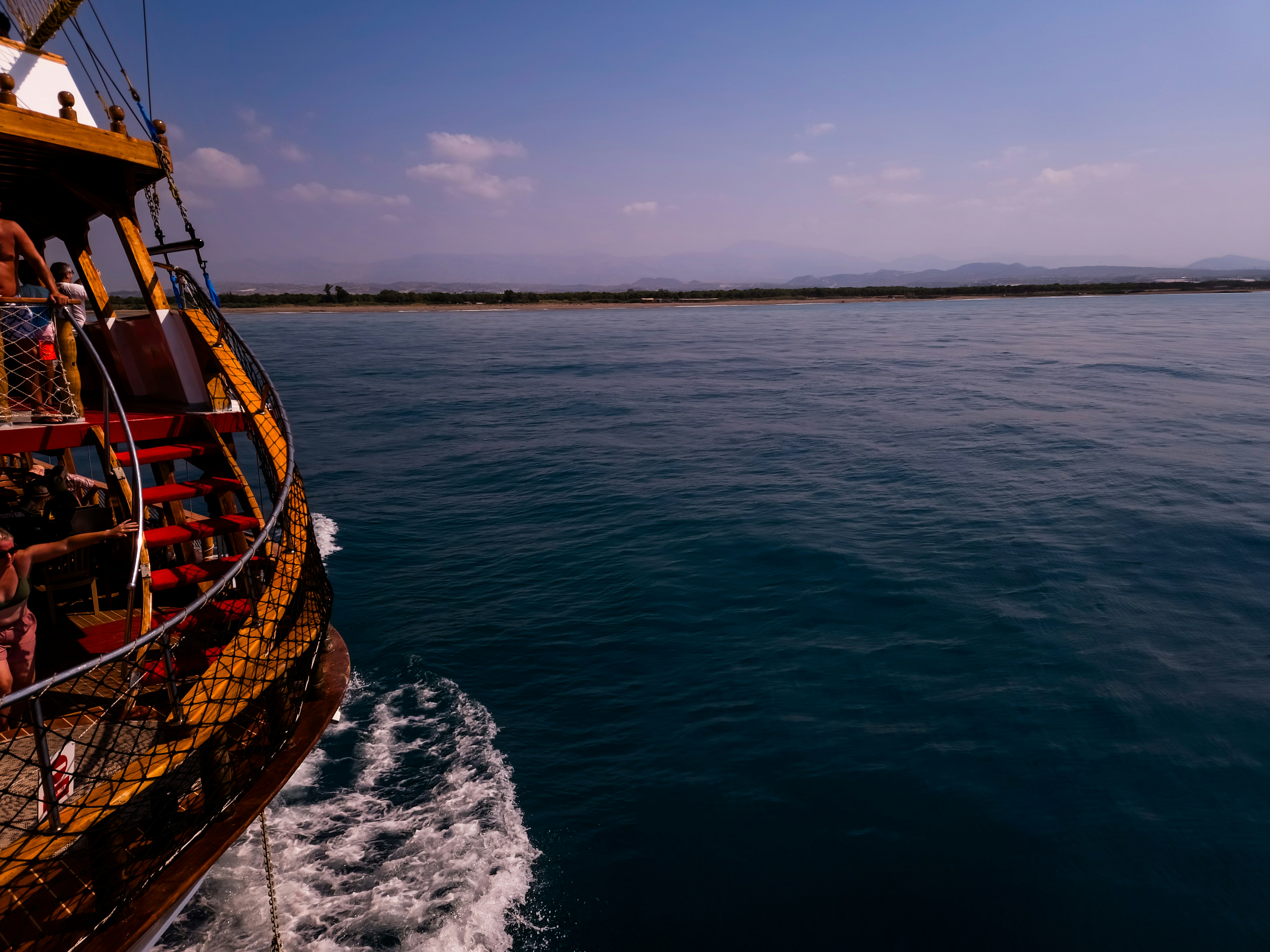 Wooden ship sailing on the calm blue sea