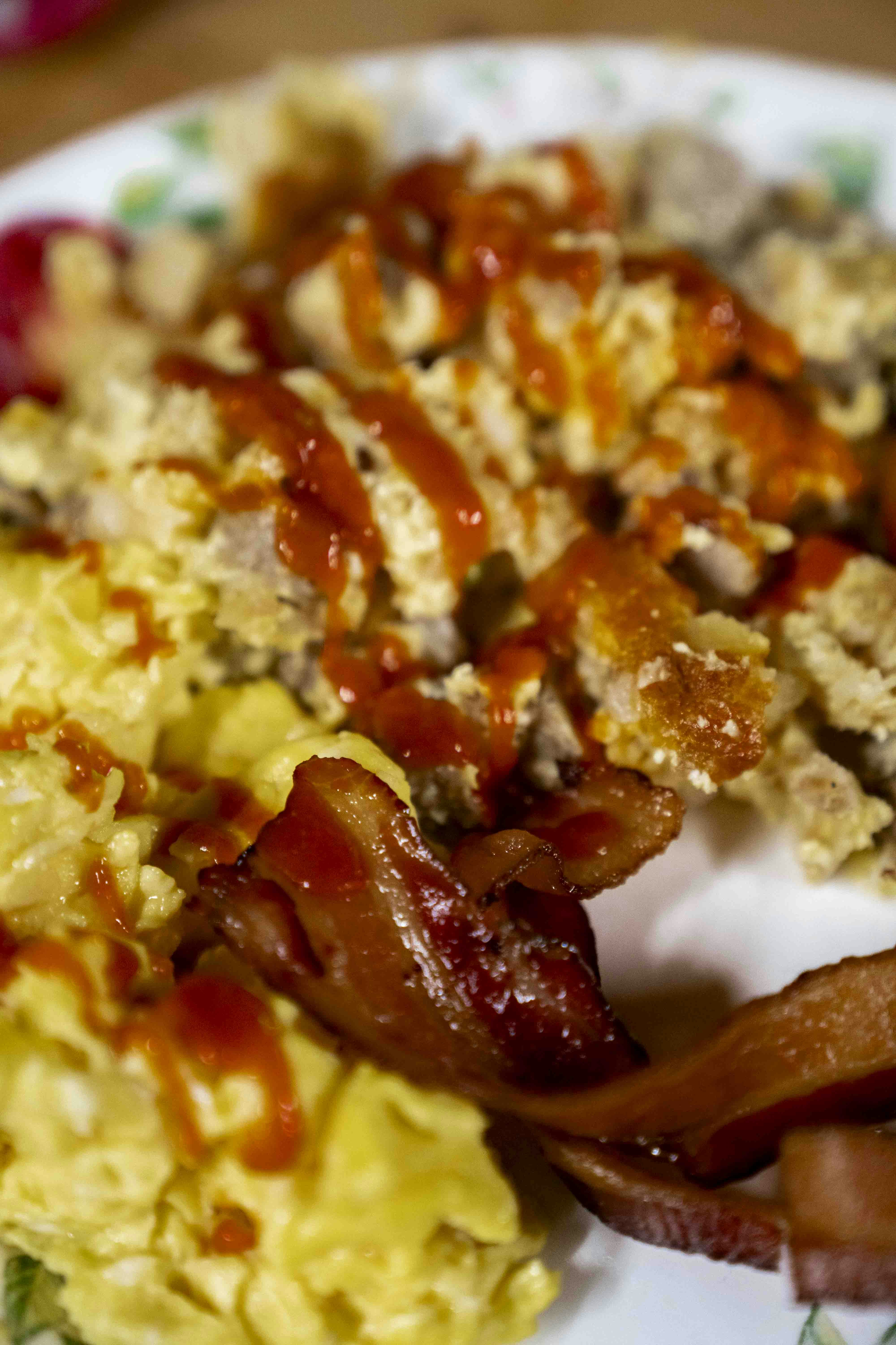 Breakfast-plate Mosaic: Scrambled Eggs, Crispy Bacon, and Diced Potatoes with Drizzle