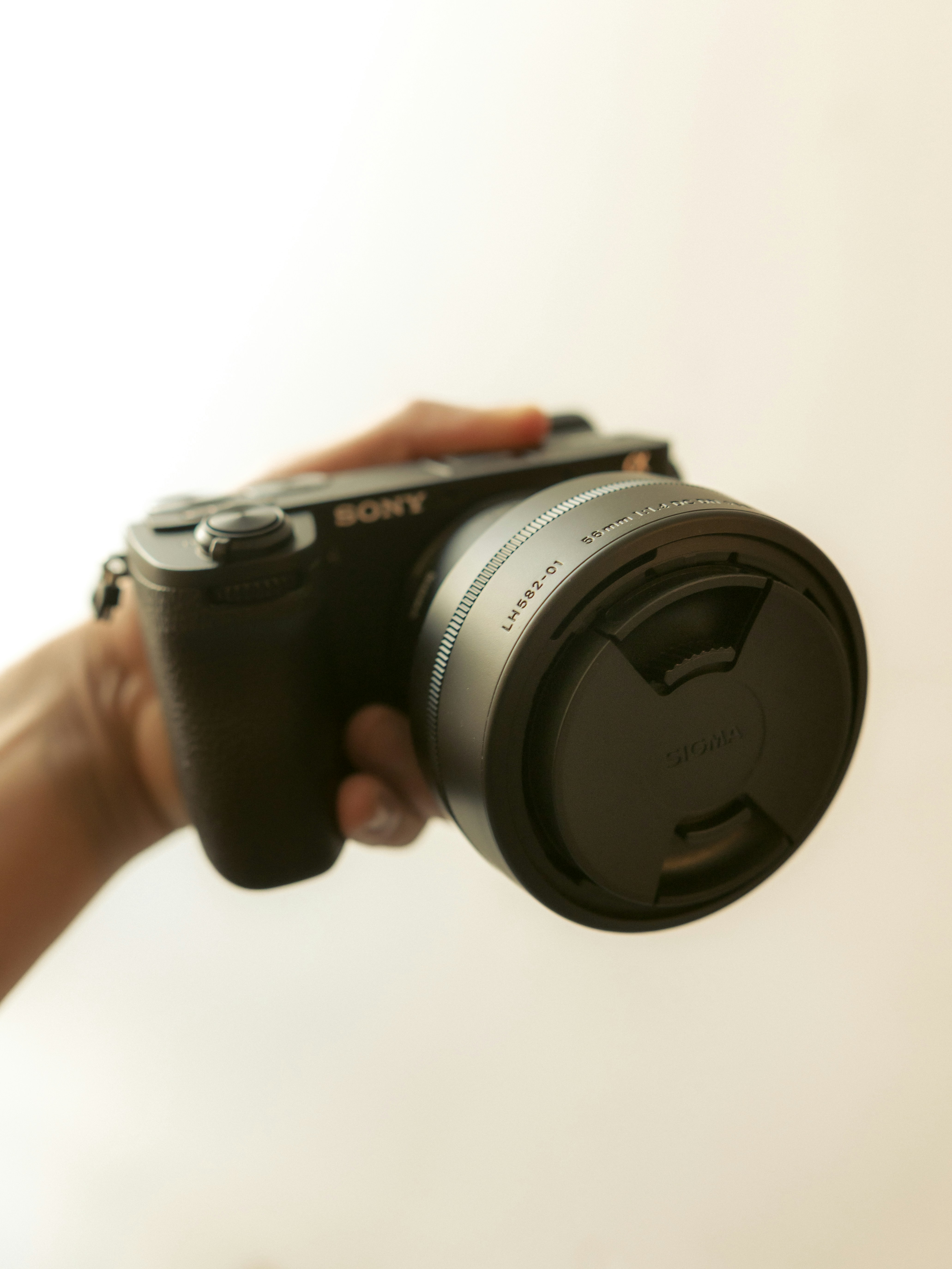 6 AUGUST 2025 | Hand holding a black sony camera with lens