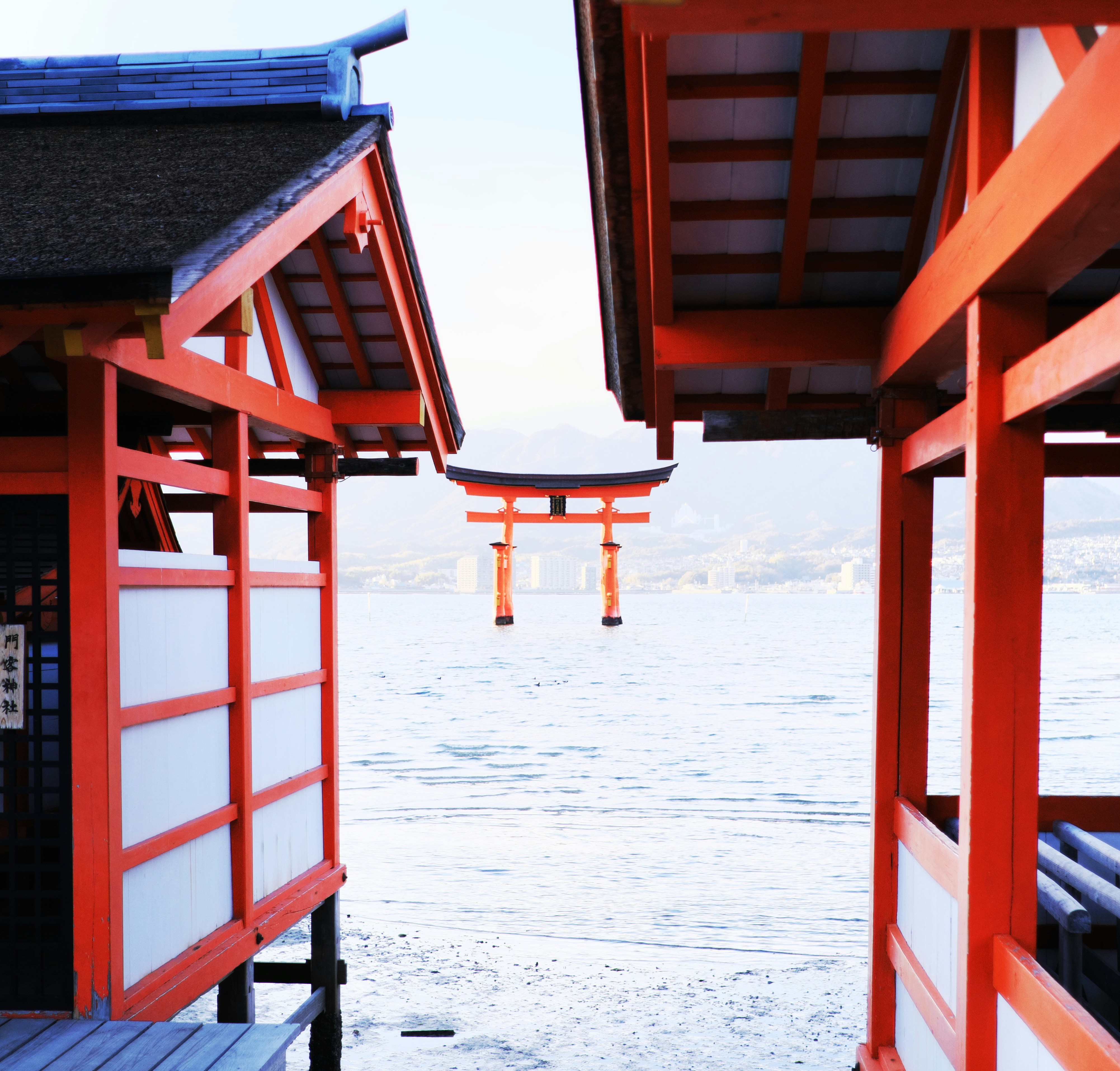 Red Torii Gate Framed by Waterfront Pavilions