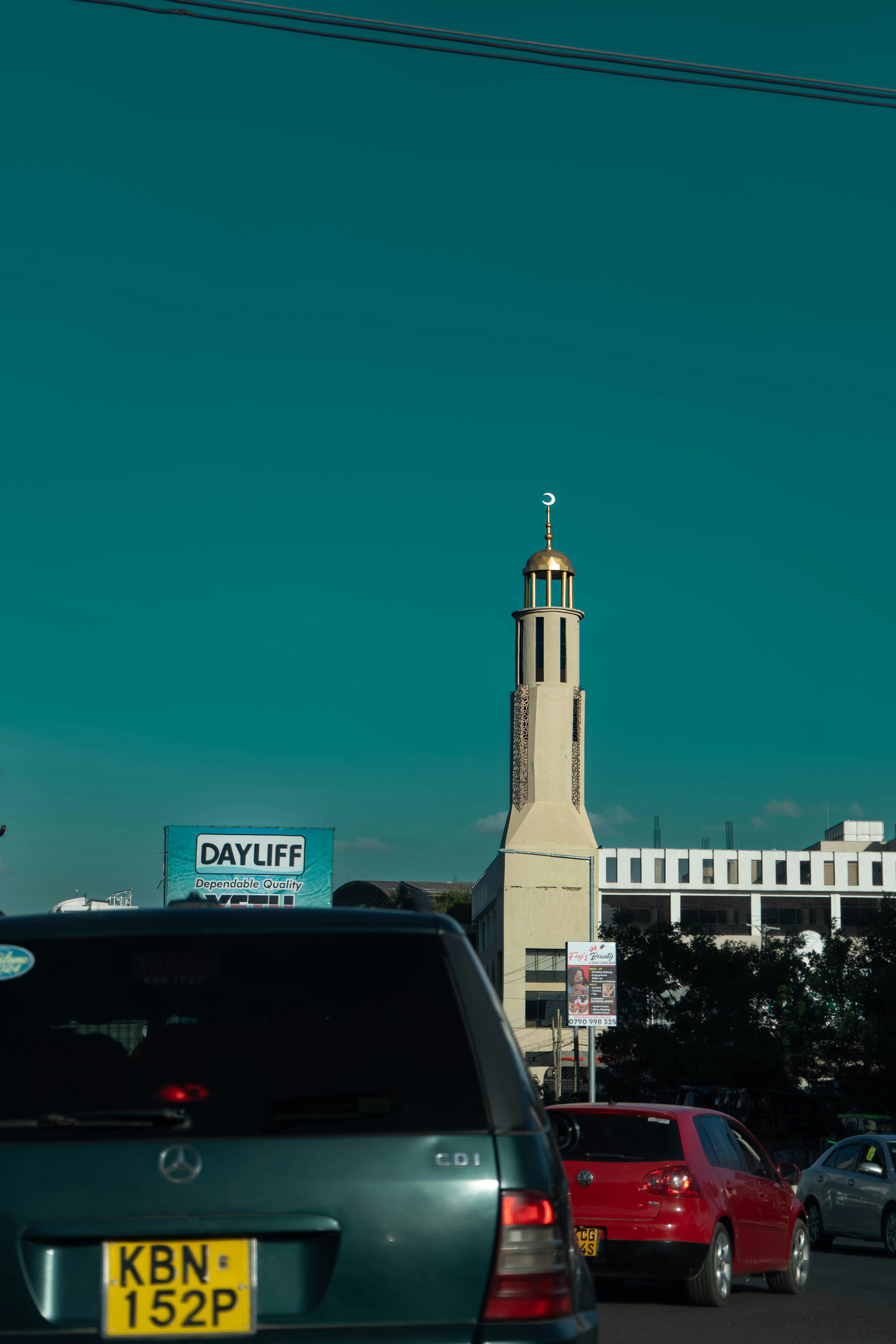 Urban Harmony: The Iconic Spire Amidst City Life