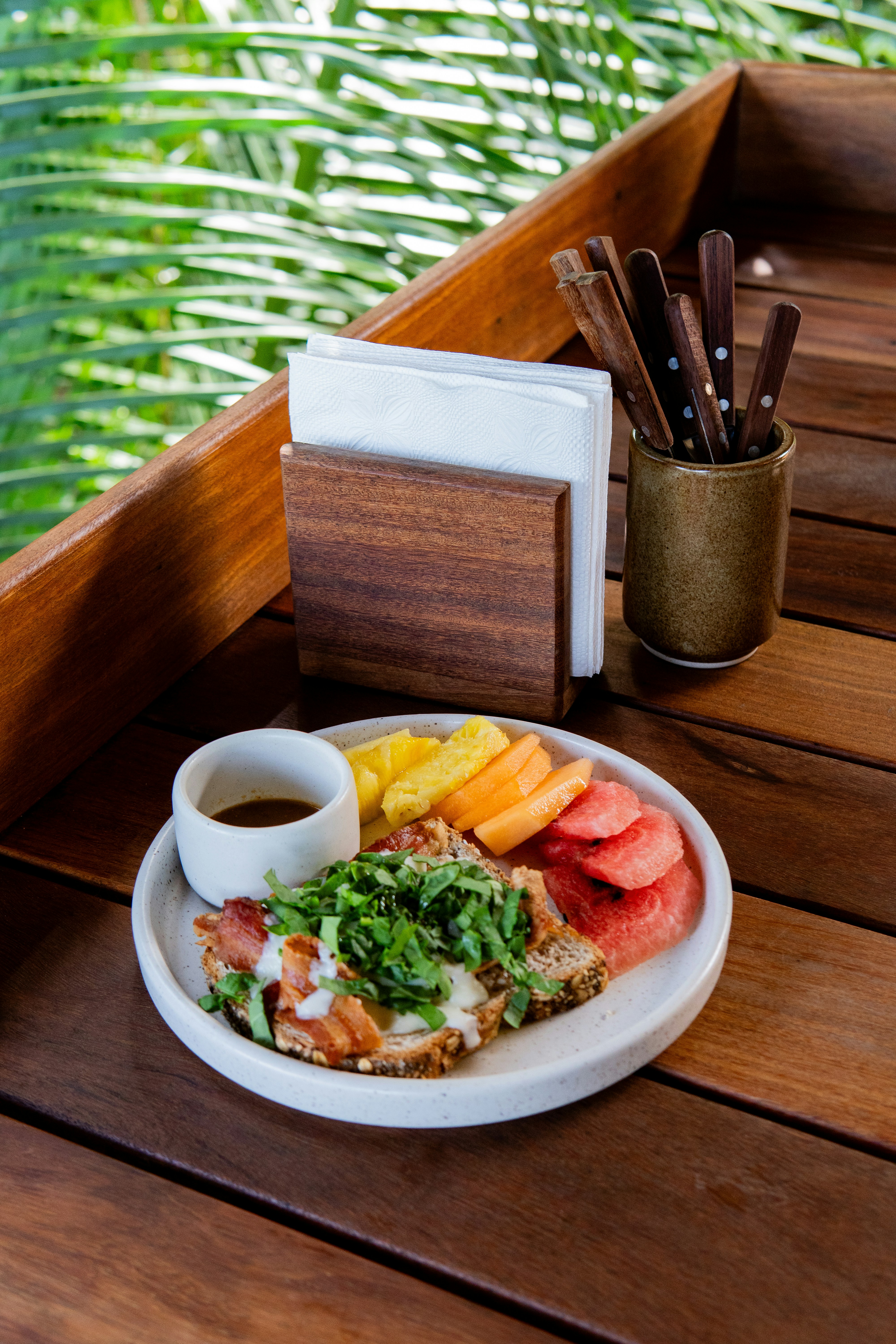 Rustic Wood Table Platter: Toasted Bread, Fresh Greens, and Citrus Medley