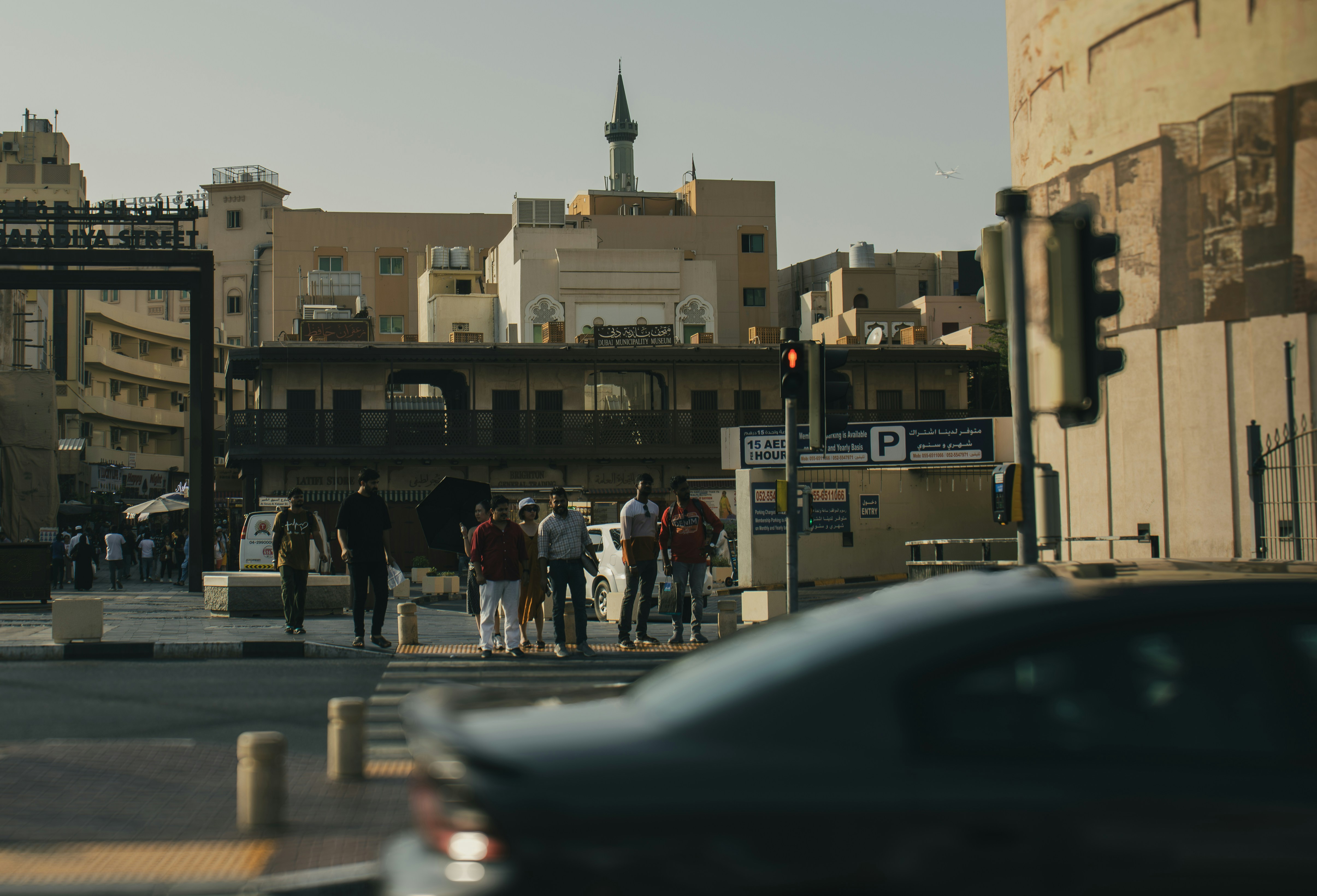 People crossing a busy street in a city.