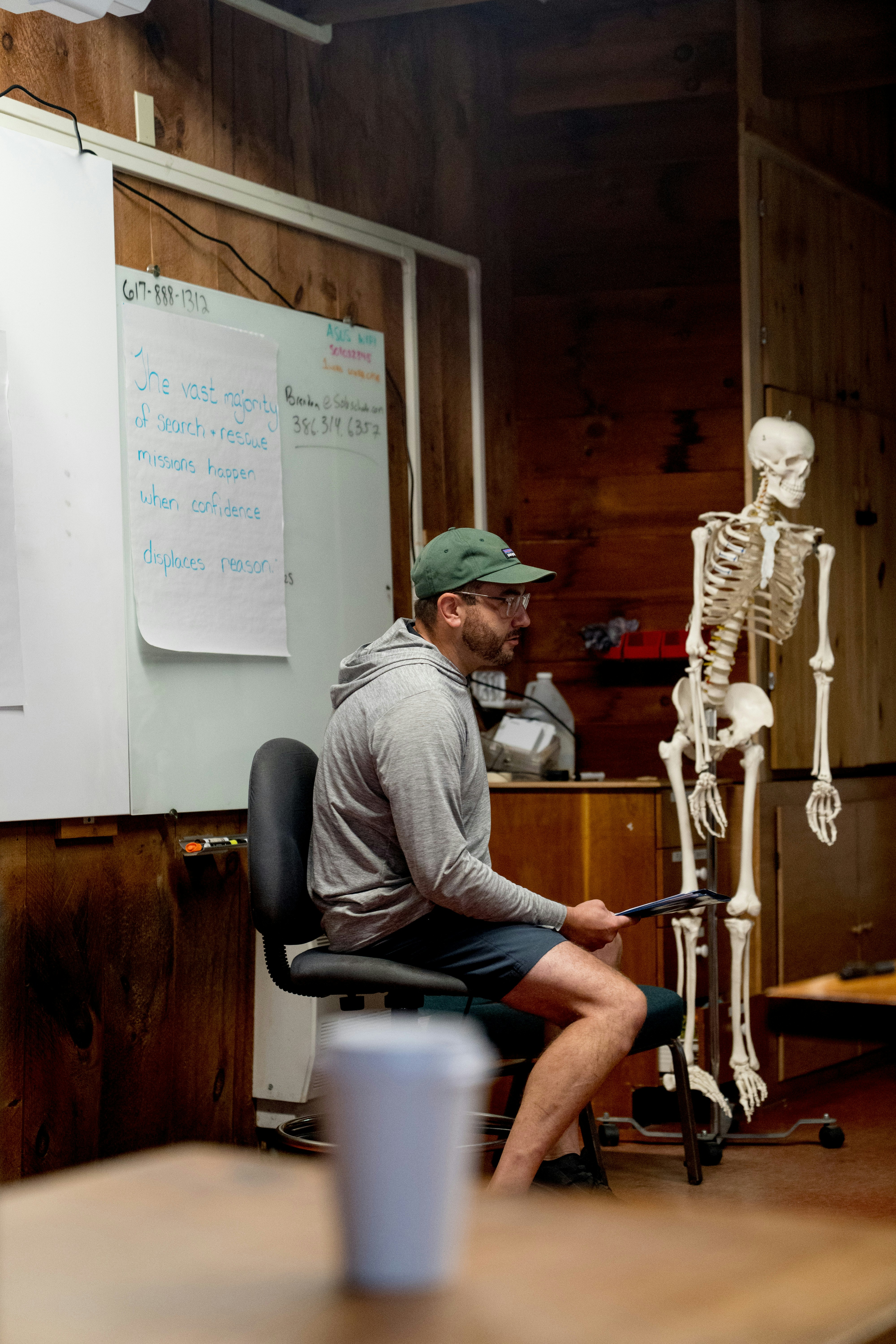Instructor in a Studio: Focused Moment with Skeleton Nearby