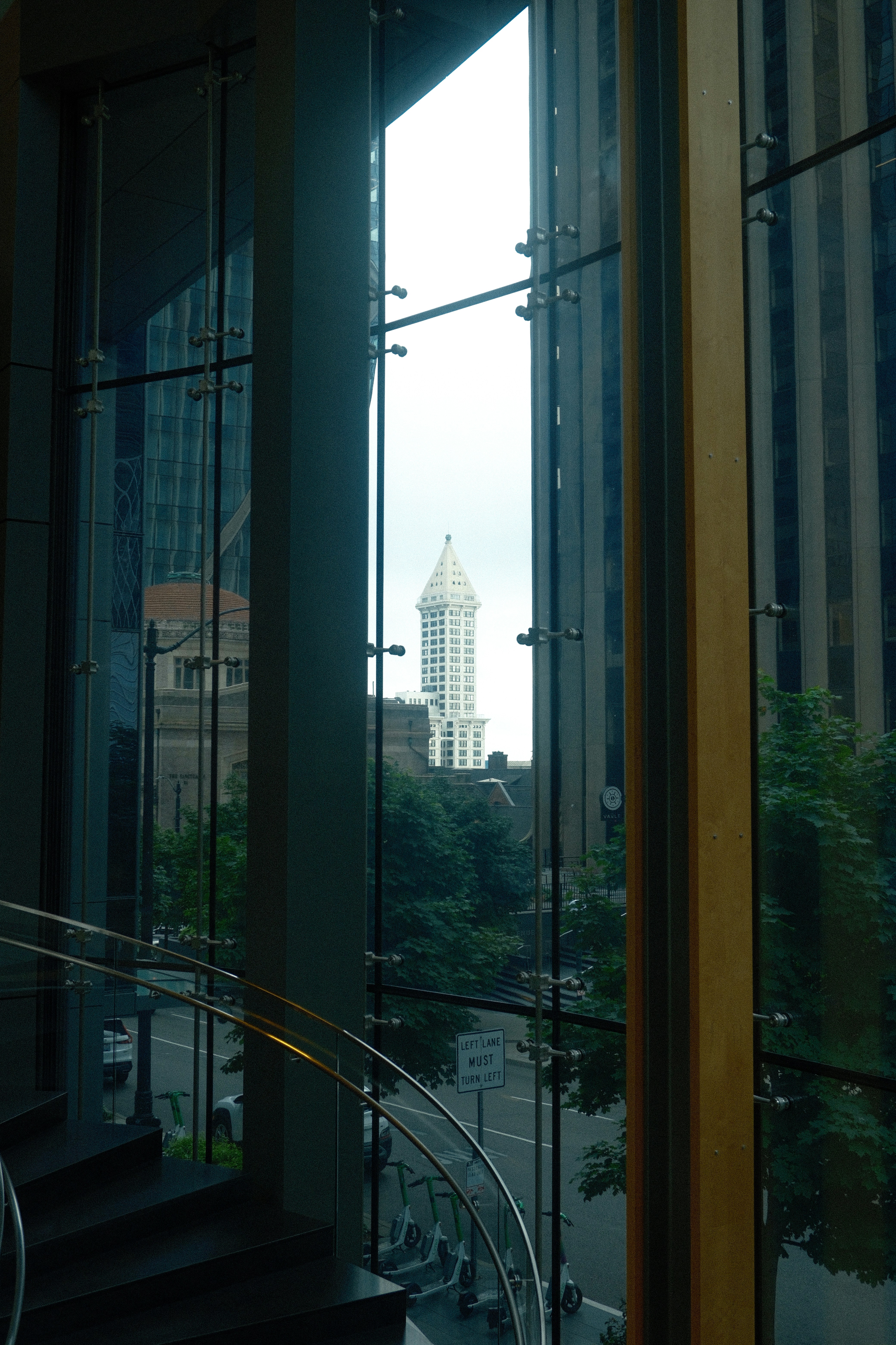 View of a tall white building through glass windows