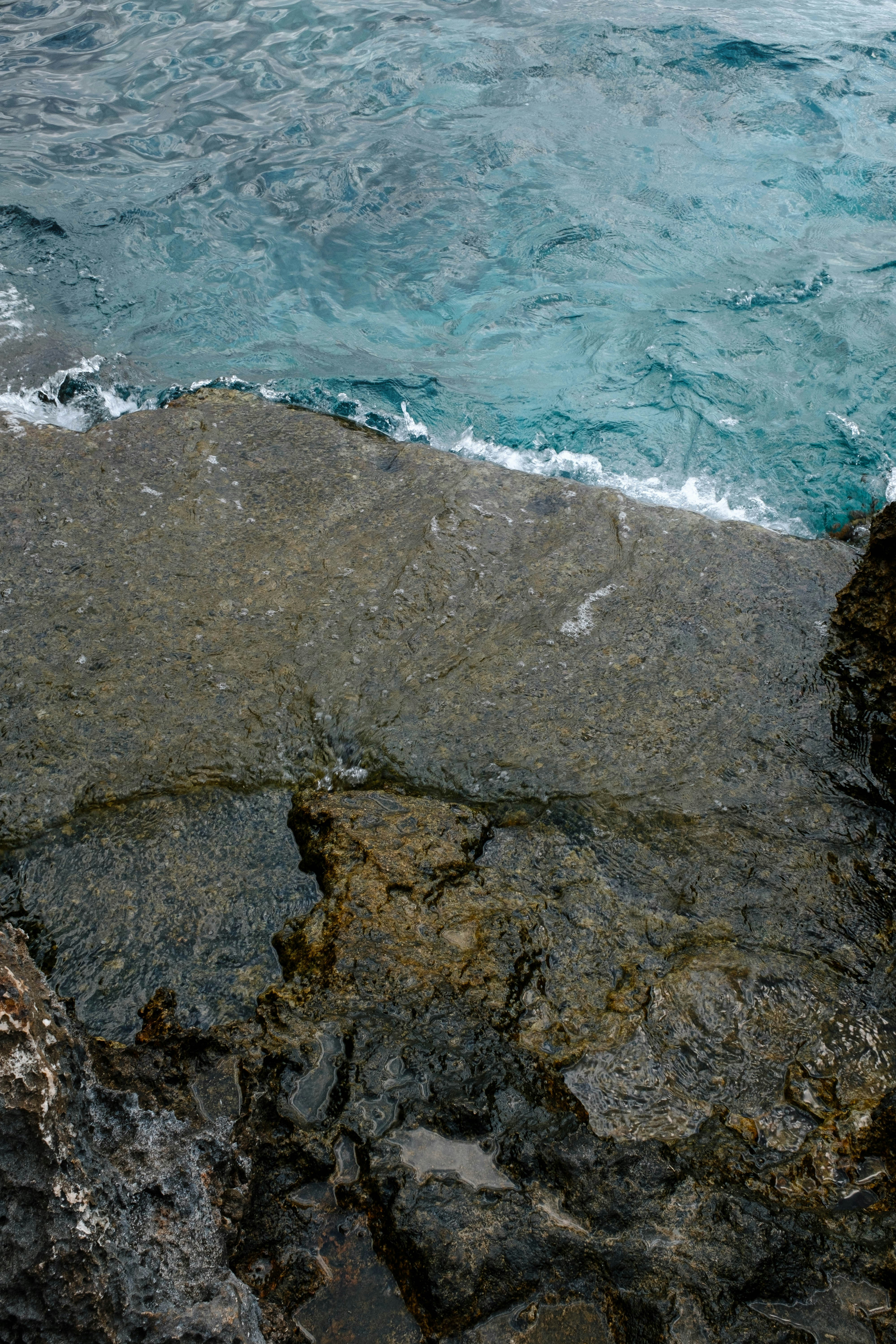 Waves gently lapping on a rocky shore