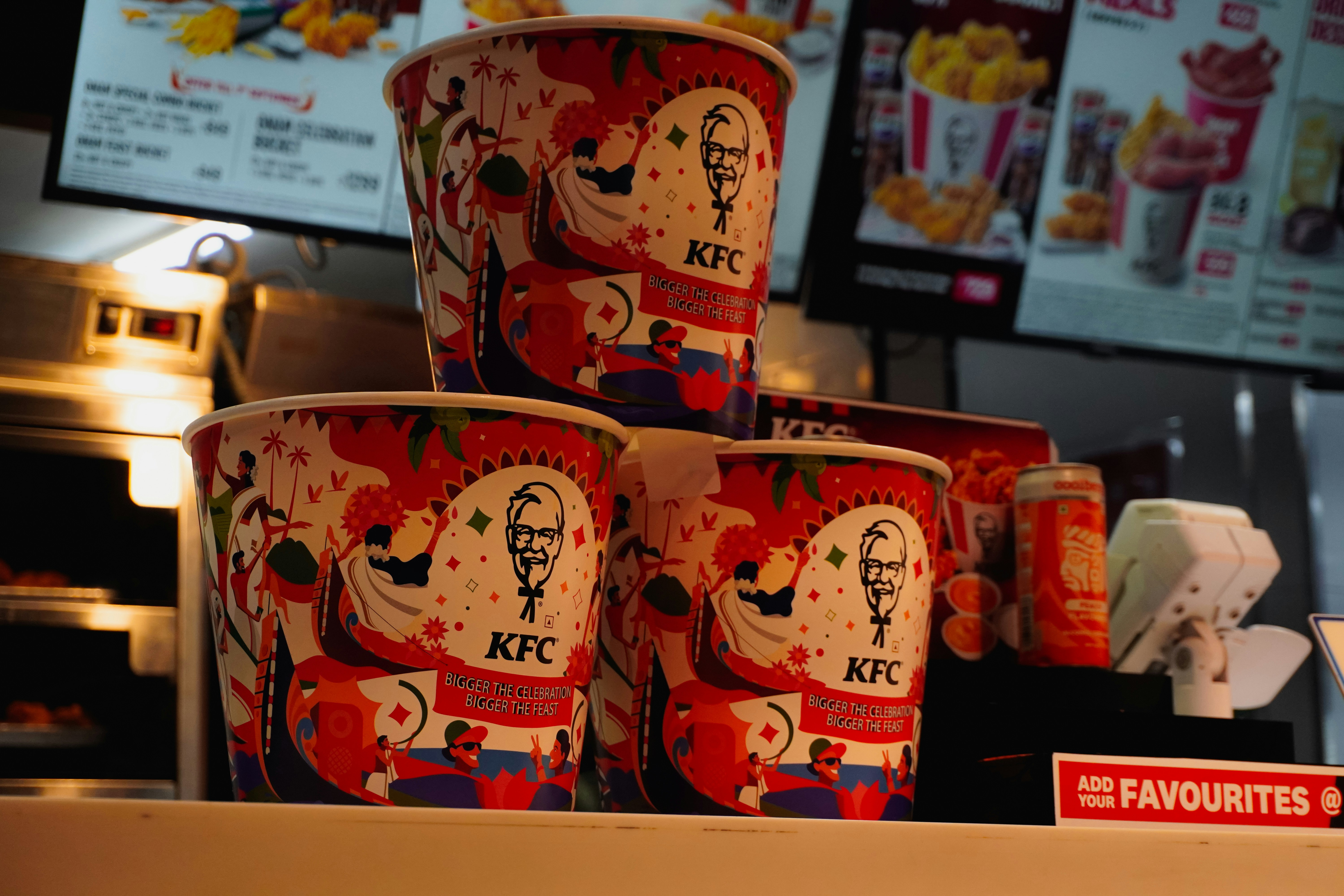 Kfc cups with festive holiday designs stacked on a counter photo – Free ...